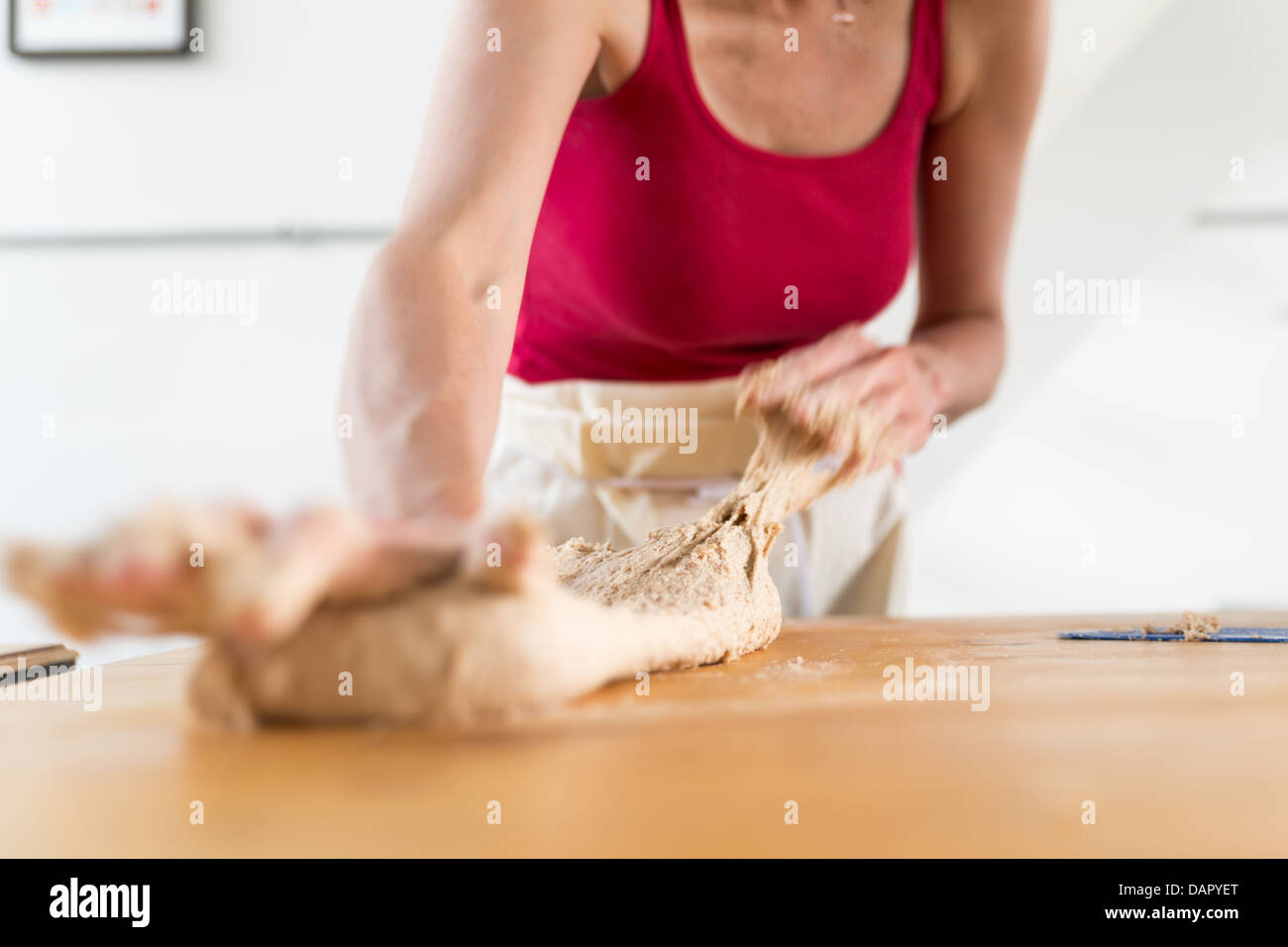 Woman Stretching Bread Stock Photo - Alamy