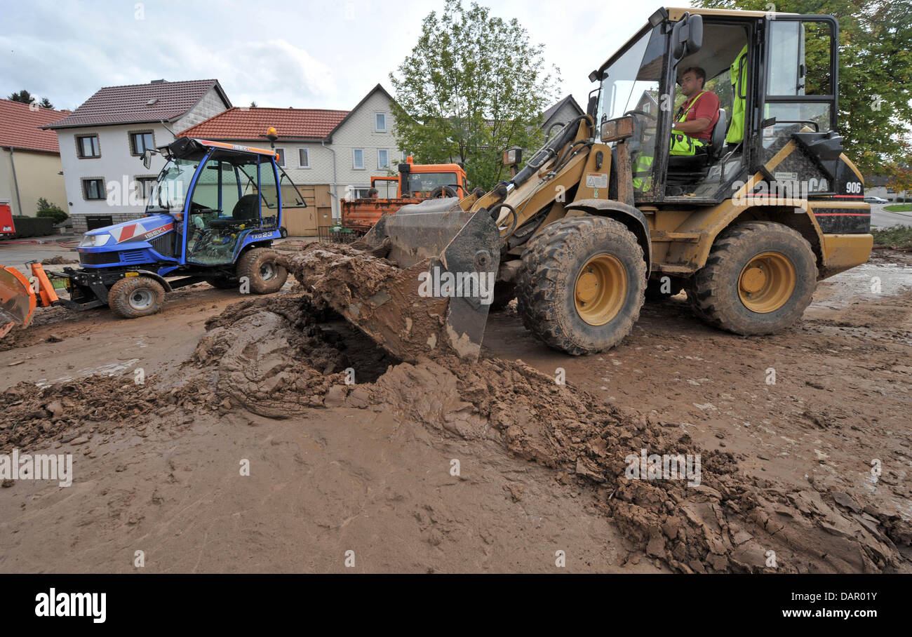 The mud in being cleared with heavy machinery in Bischofferode, Germany ...