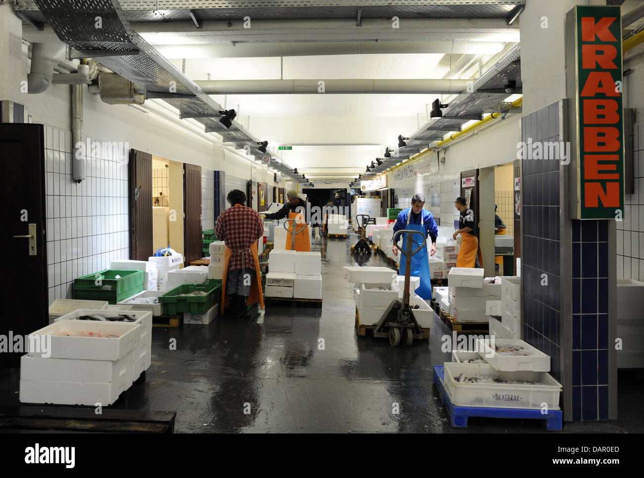 Buyers and employees walk through the fish market in Hamburg, Germany ...