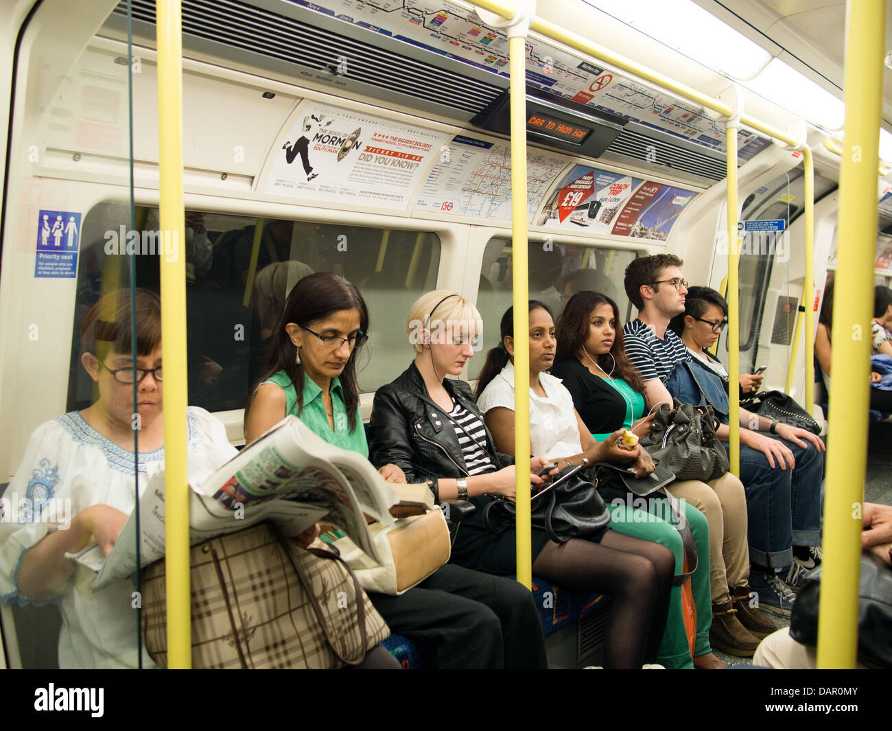 People sitting on a tube Stock Photo - Alamy