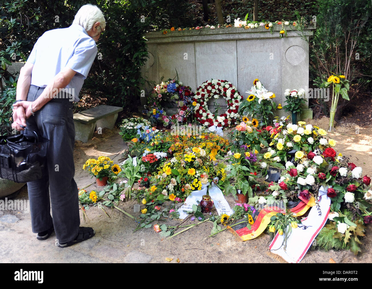 Flowers and floral wreaths lie on the grave of German comedian Vicco ...