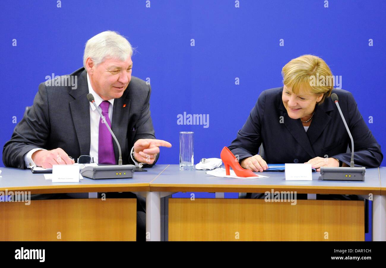 German Chancellor Angela Merkel and DGB head Michael Summer look at a ...