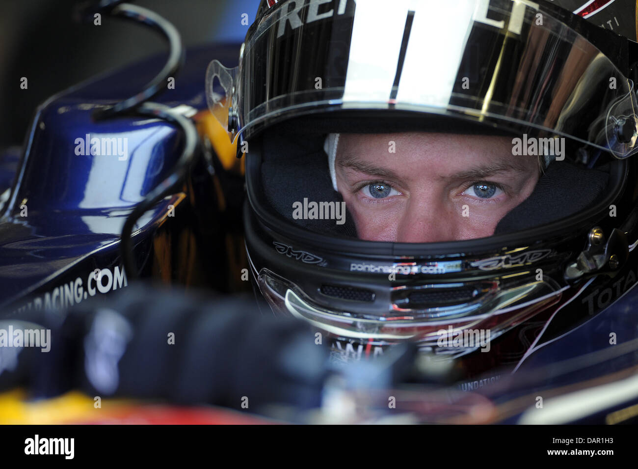 German Formula One driver Sebastian Vettel of Red Bull sits in his car ...