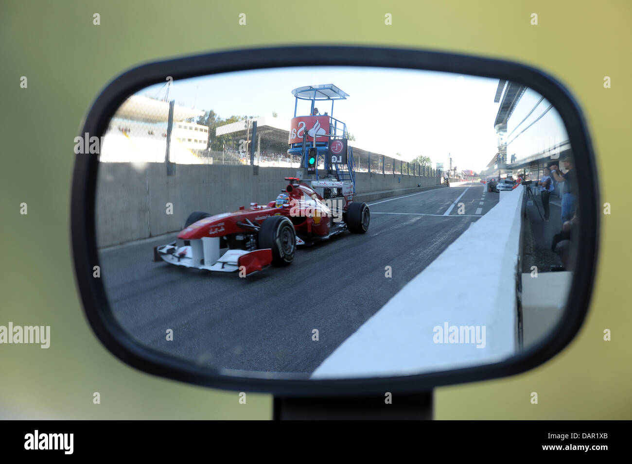 Spanish Formula One driver Fernando Alonso of Ferrari is mirrored in a ...