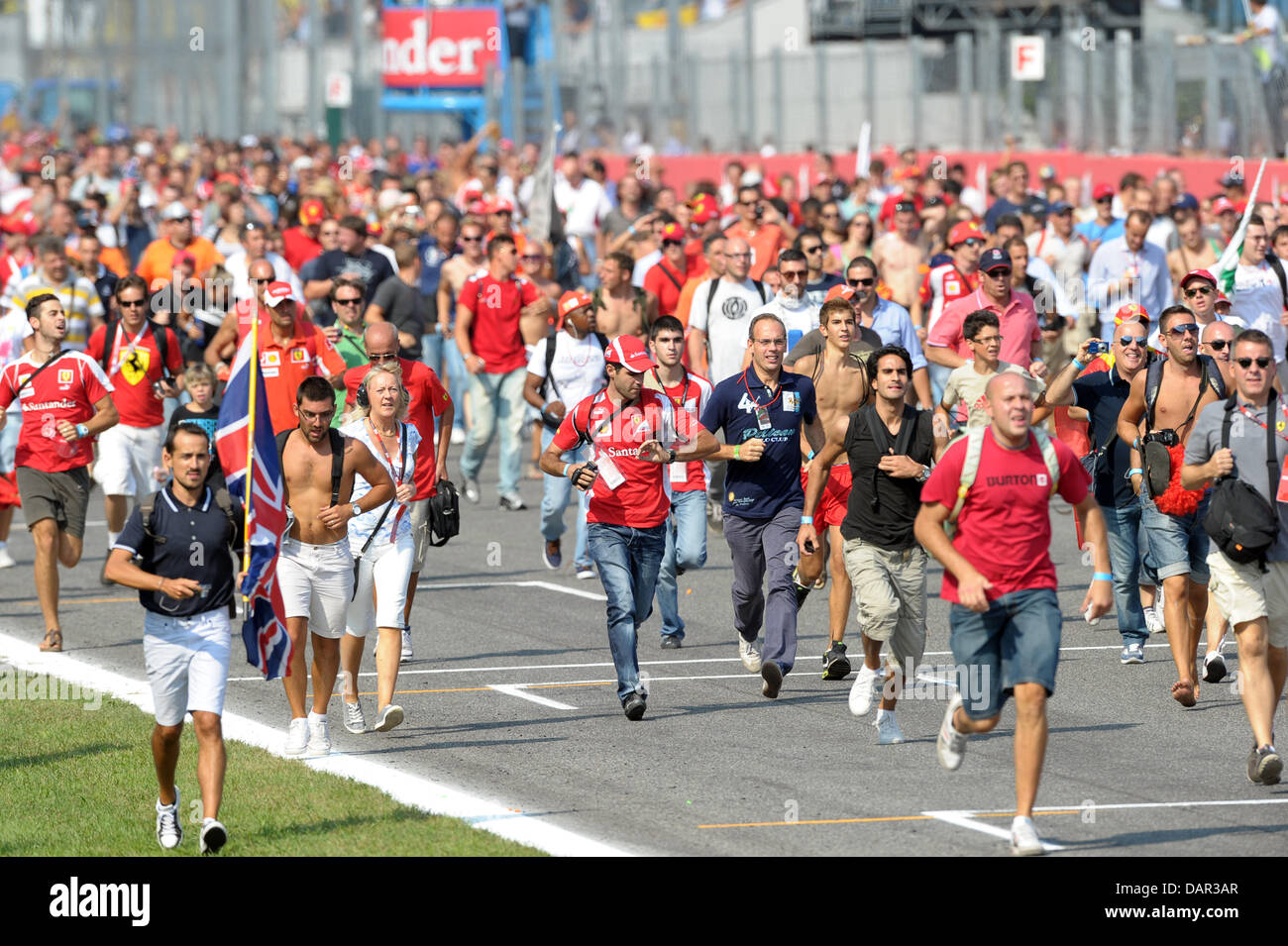 Fans enter the track to see the podium of the Italian GP at the race ...