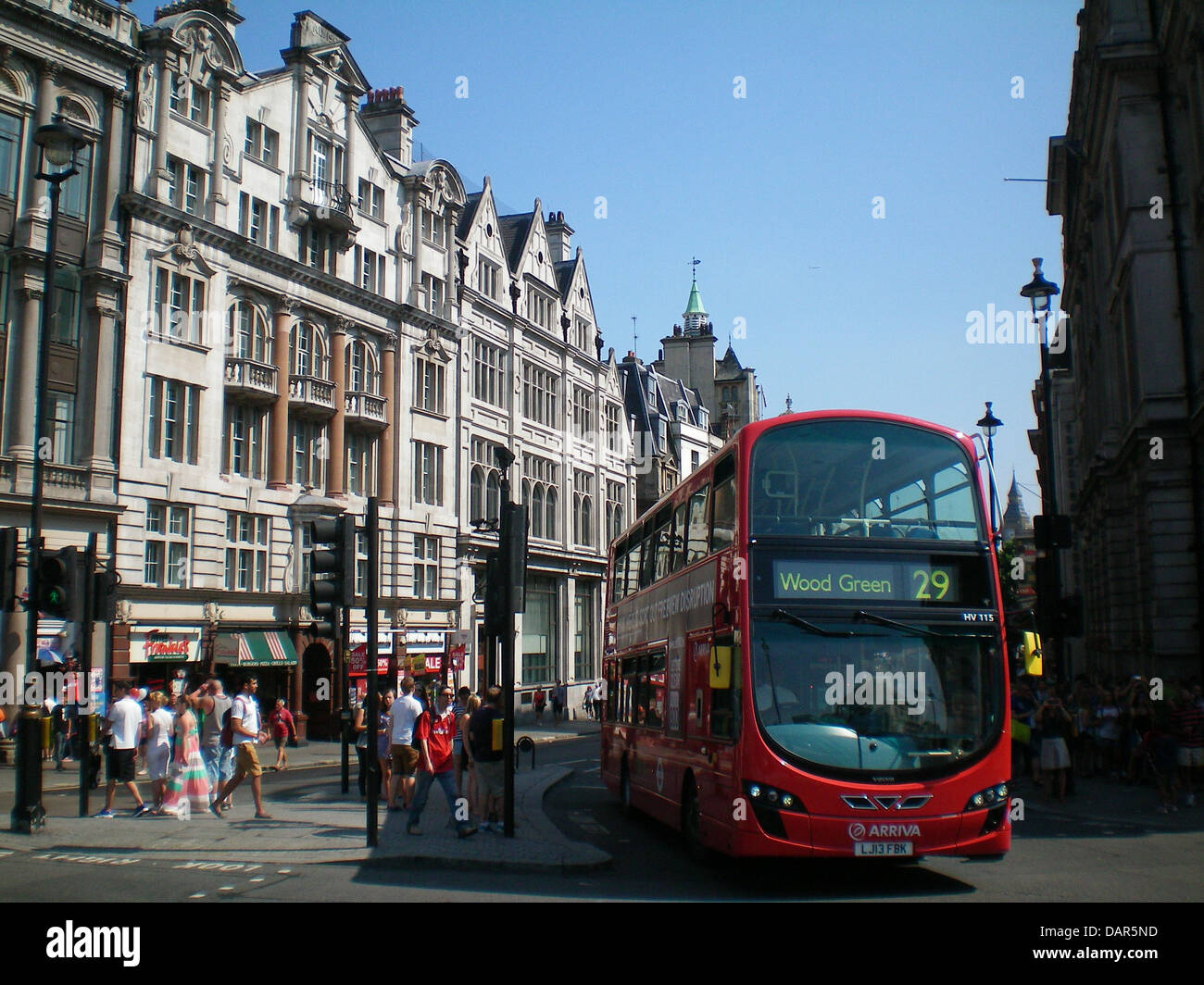 A busy street scene in London, England, featuring iconic double-decker ...