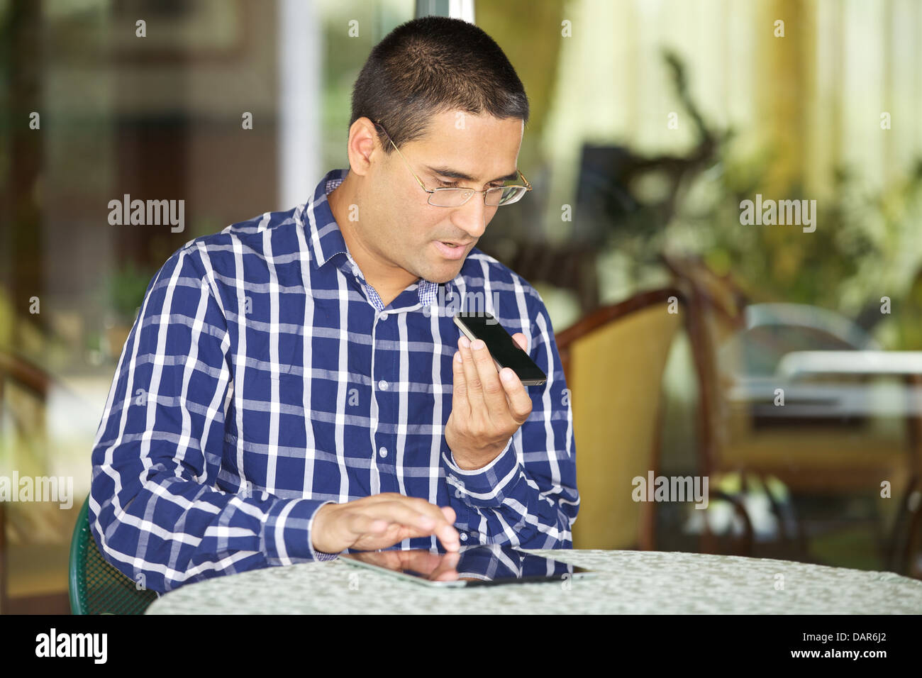 Man talking on the phone and manipulating ipad Stock Photo - Alamy