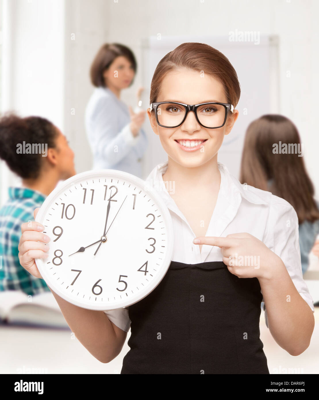 attractive student pointing at clock Stock Photo - Alamy