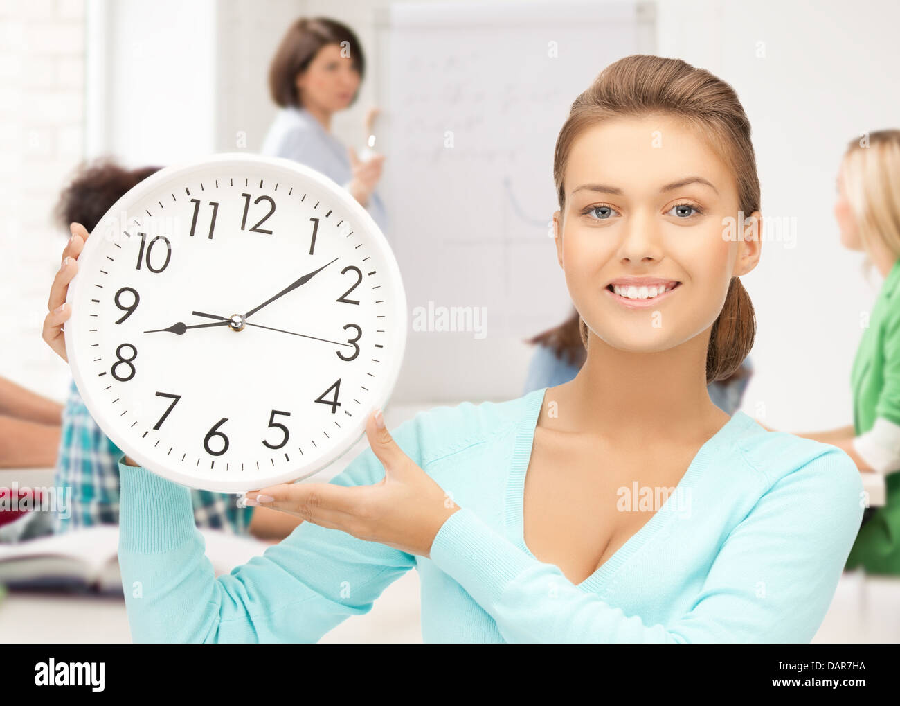 attractive student pointing at clock Stock Photo - Alamy