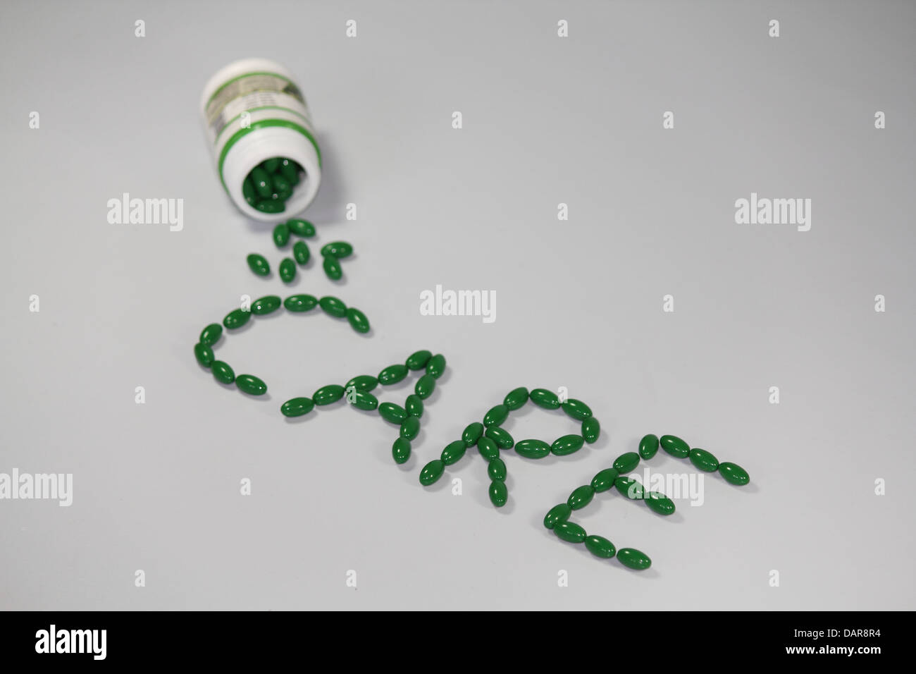 Care Word with cross symbol arranged with pills Stock Photo - Alamy