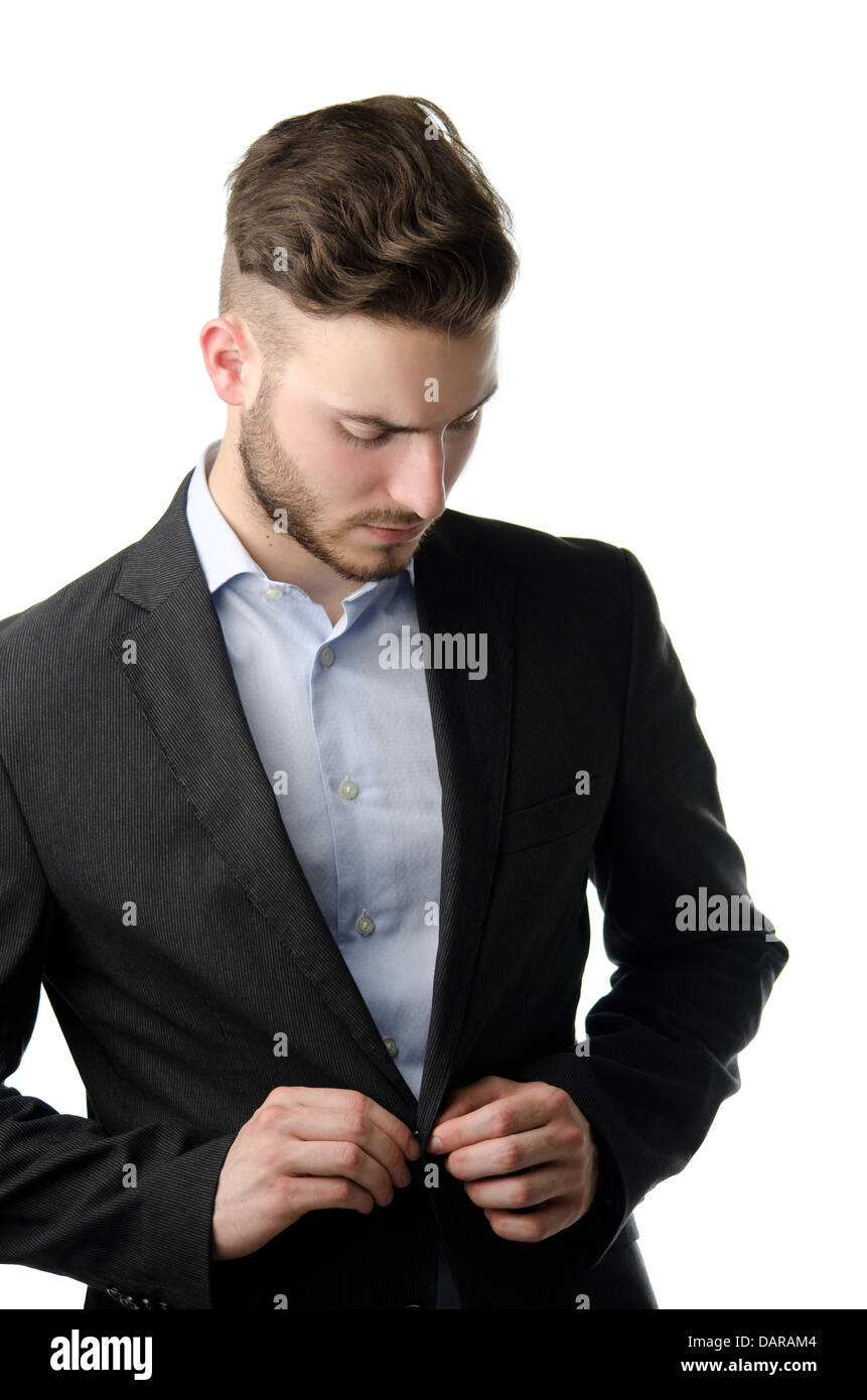 Attractive young man in suit buttoning up elegant jacket, isolated on ...