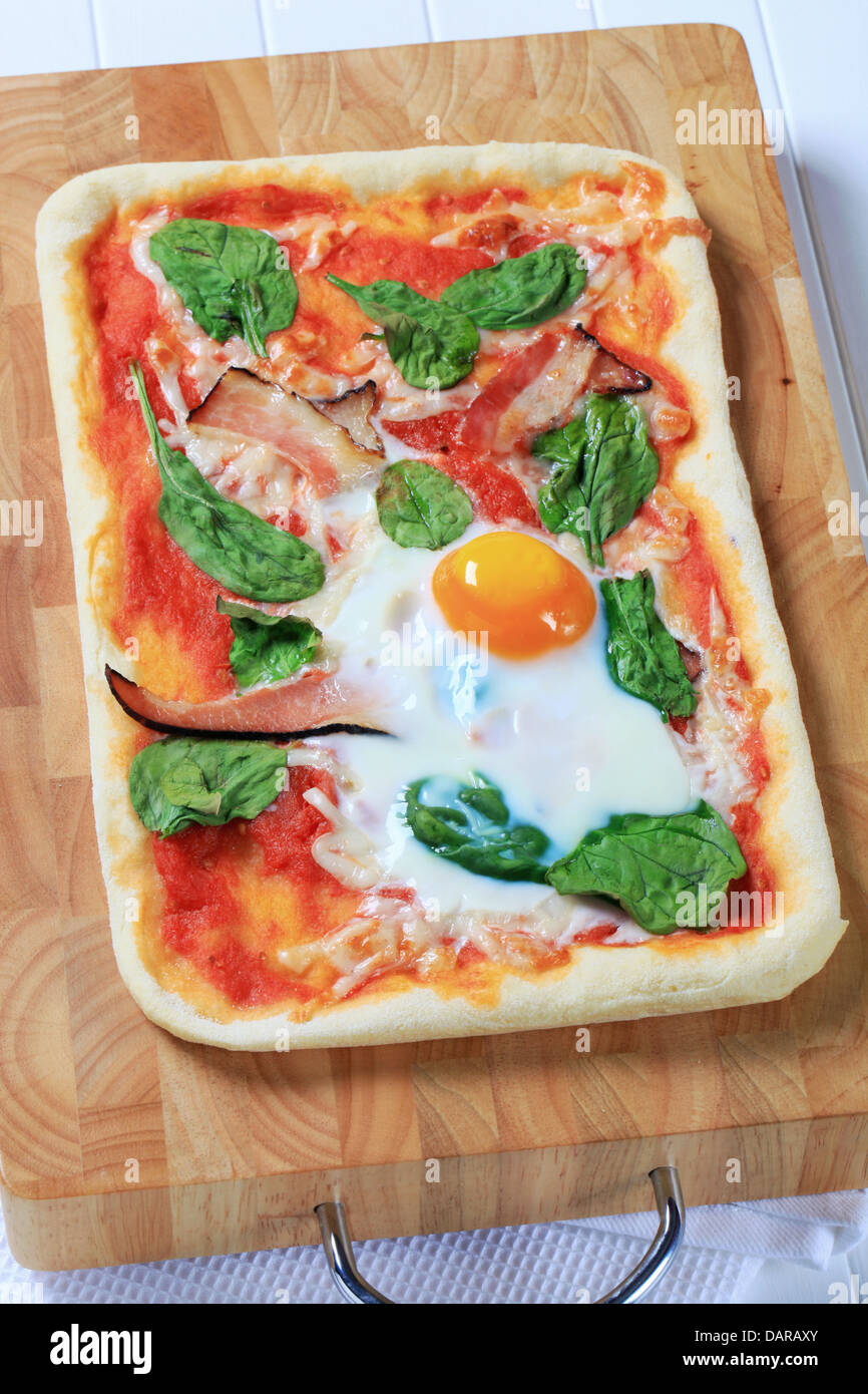 Bacon and egg pizza baked in a rectangular tray Stock Photo - Alamy
