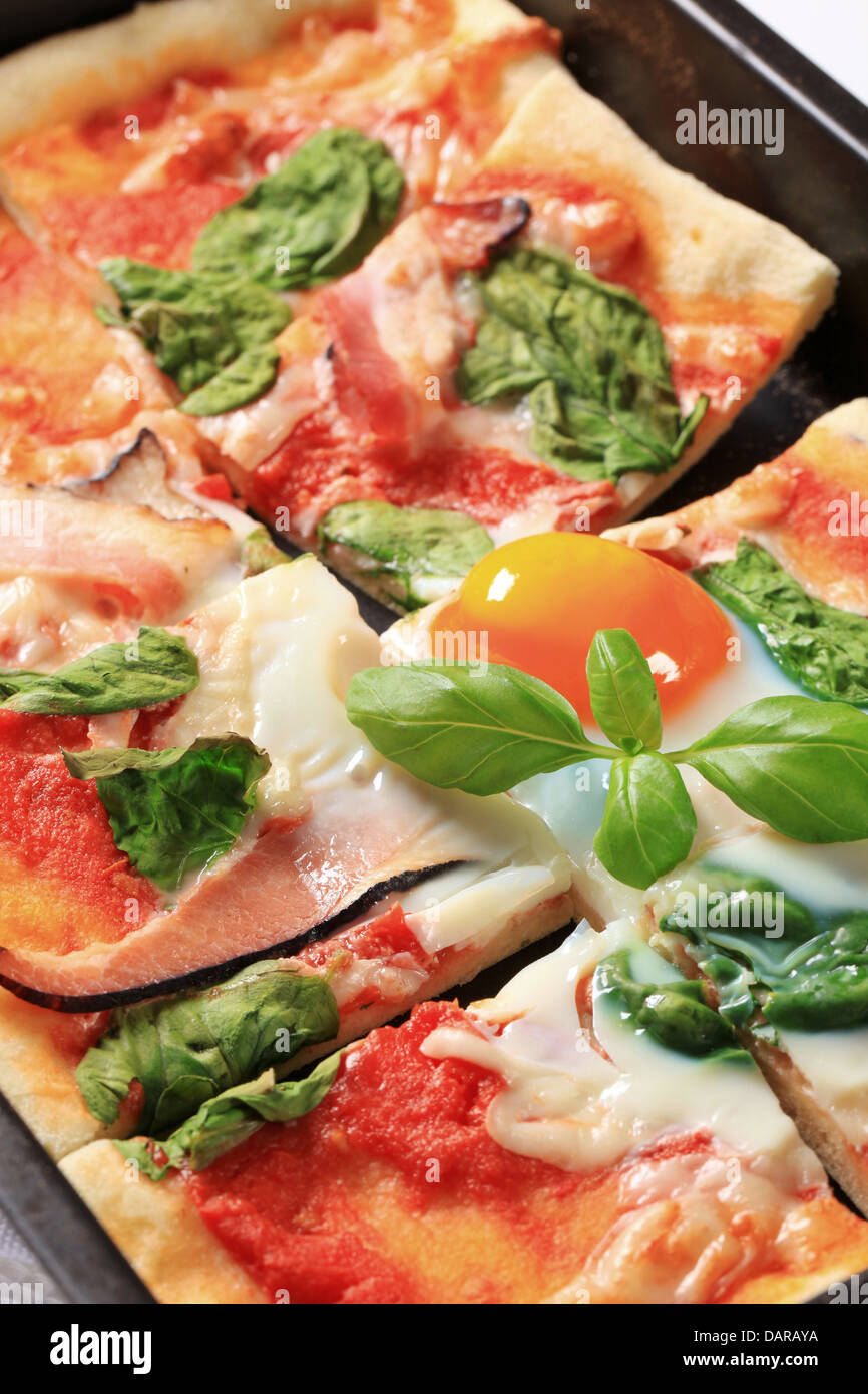 Bacon and egg pizza baked in a rectangular tray Stock Photo - Alamy