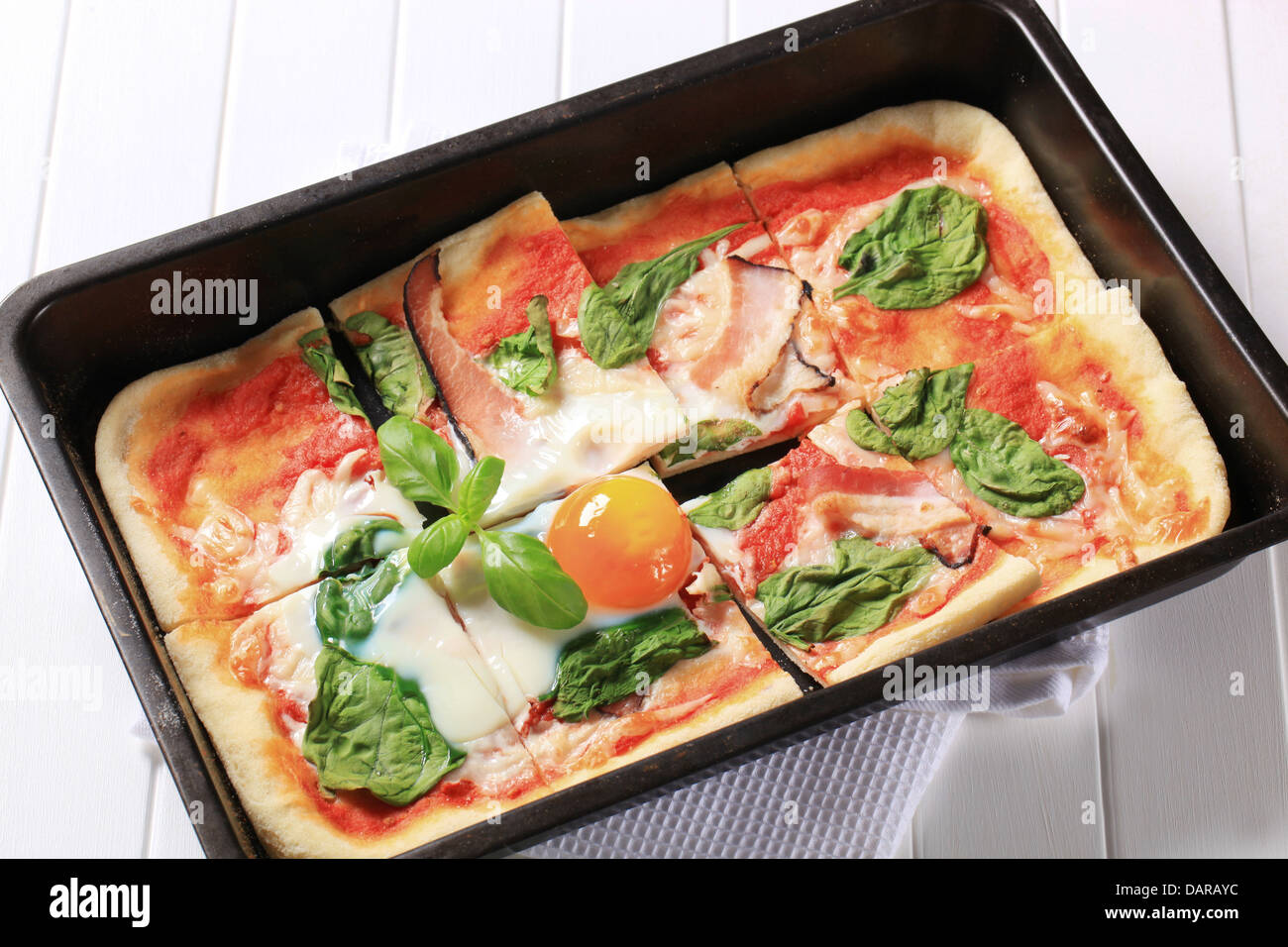 Bacon and egg pizza baked in a rectangular tray Stock Photo - Alamy