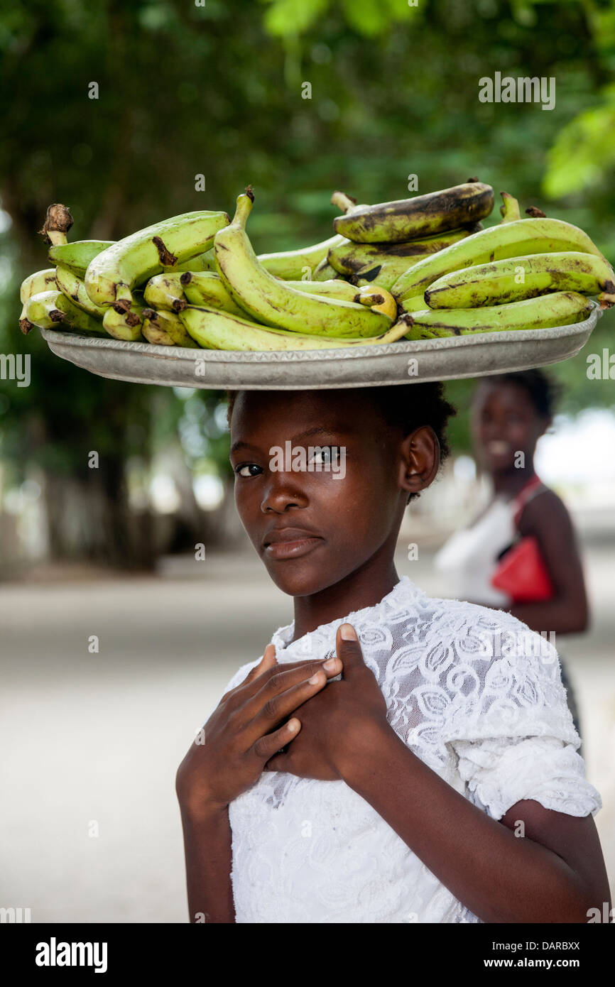 Africa, Mozambique, Mozambique Island. Teenage girl selling bananas in ...