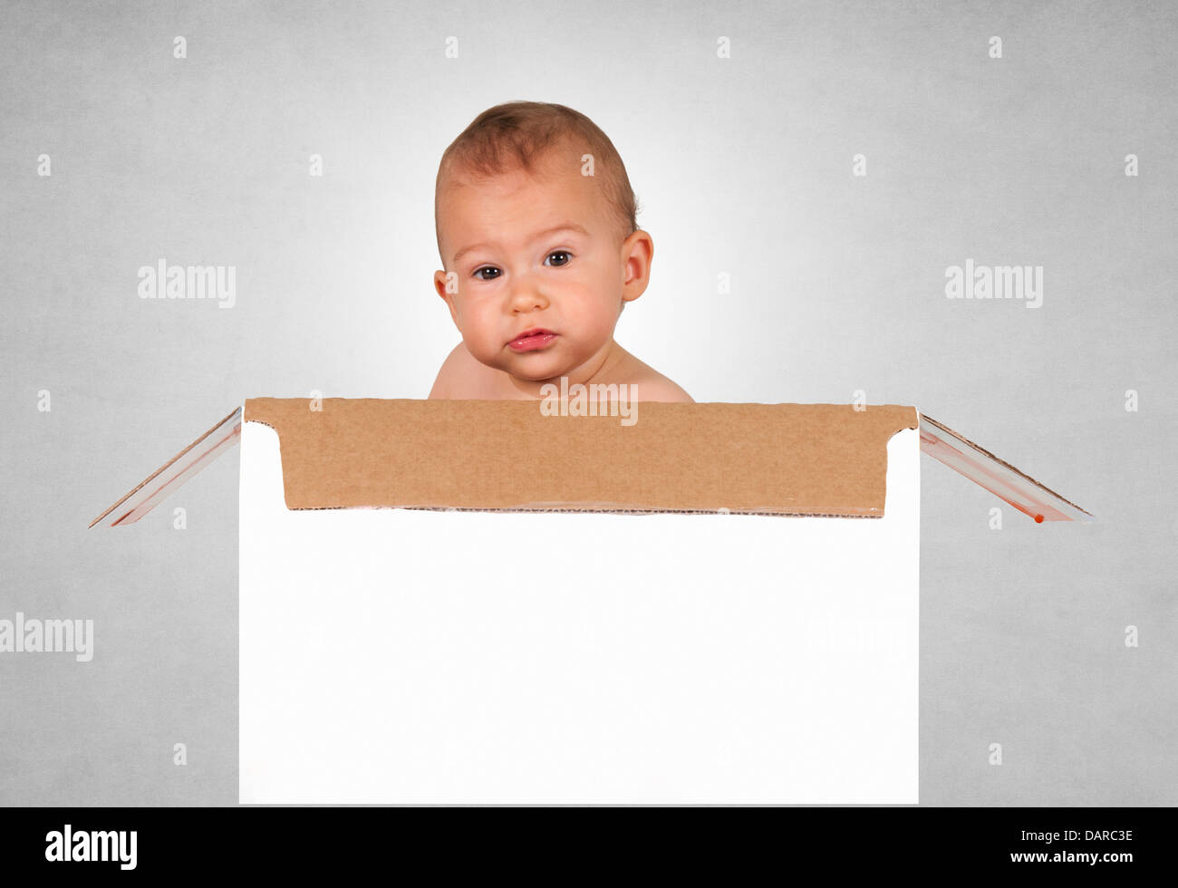 Baby making the funny face in box Stock Photo - Alamy
