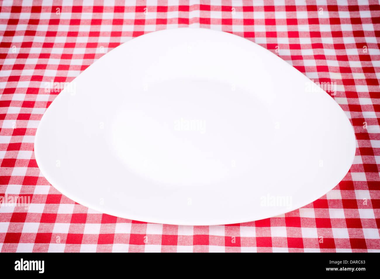 Empty white plate on the table Stock Photo - Alamy
