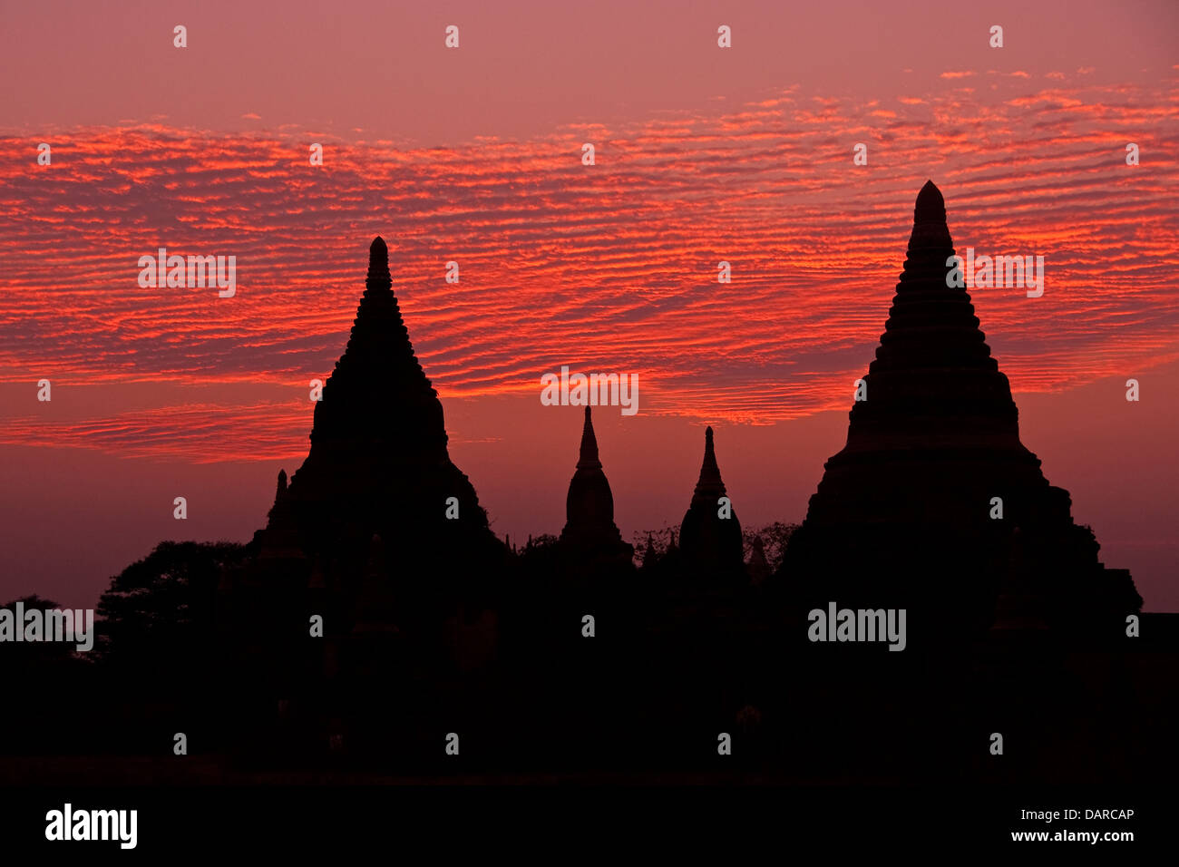 Silhouetted Buddhist pagodas on Bagan Plain at dusk in Myanmar Stock ...