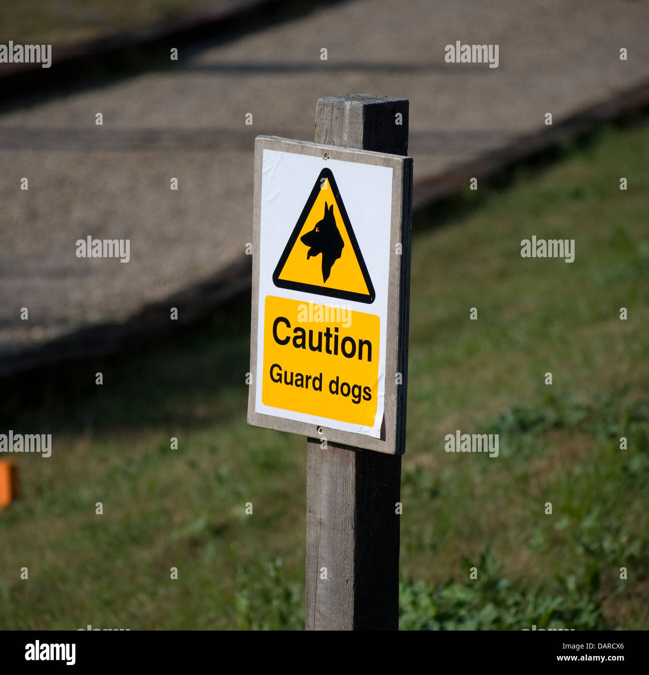 Caution Beware Of the Guard dogs sign with a blured background Stock ...