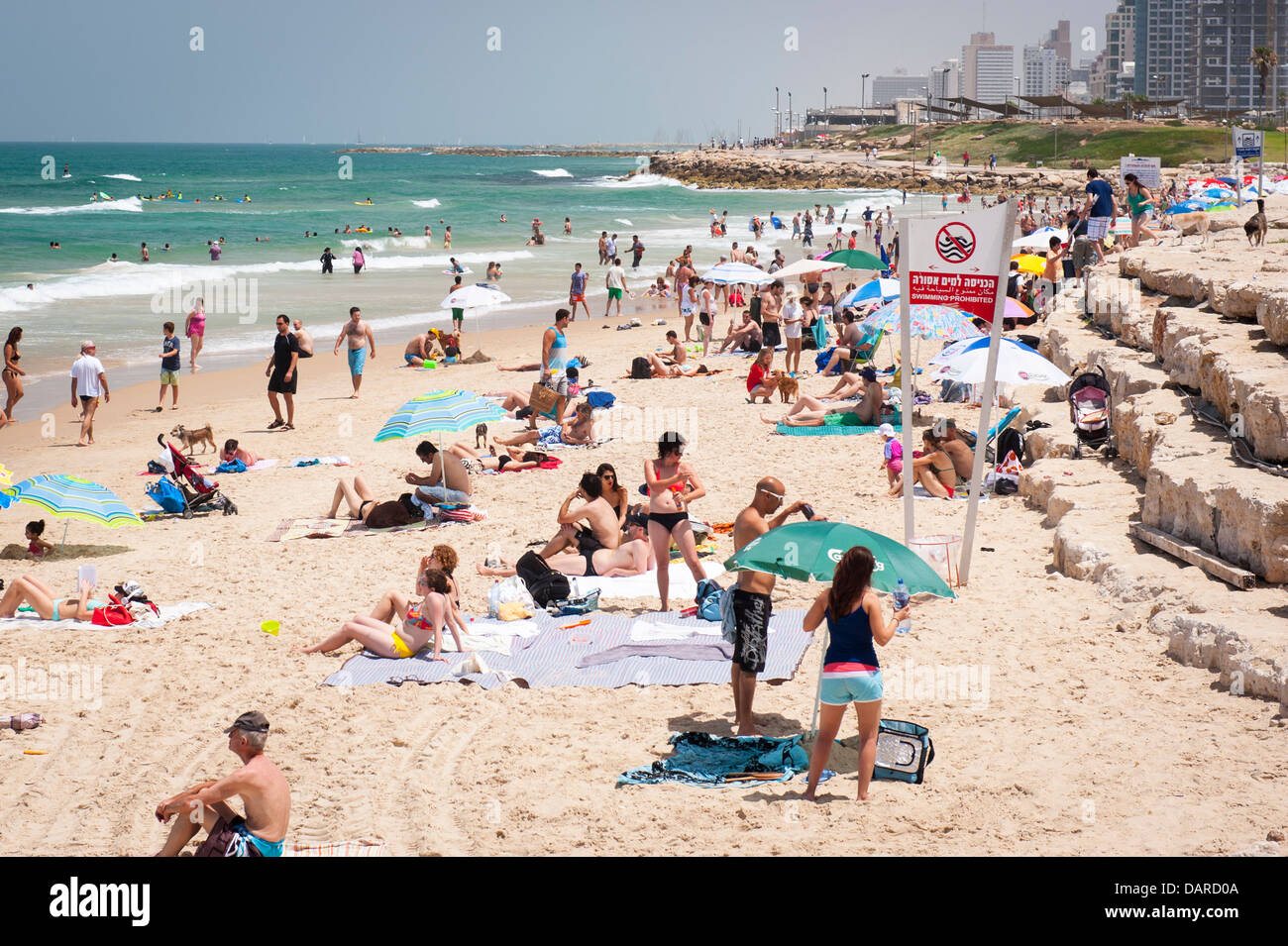 Israel Jaffa Yafo sand blue sky sea beach swimmers sunbathers parasols ...