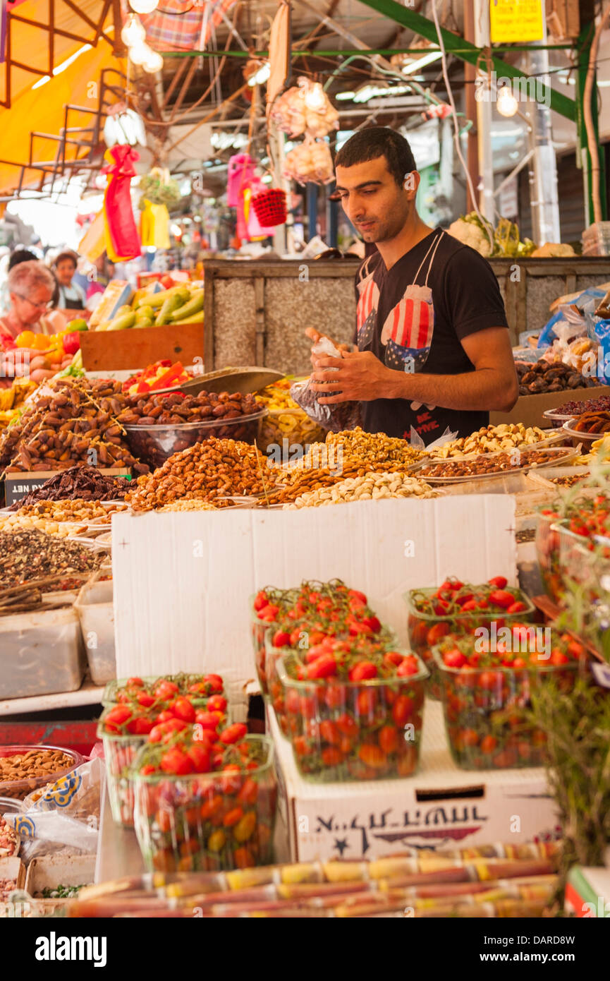 Israel Tel Aviv Carmel Market young vendor fresh nuts almonds walnuts ...