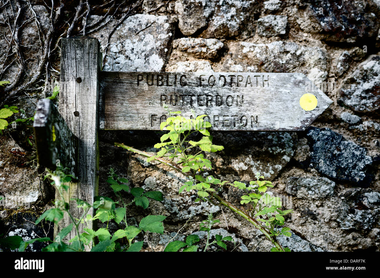 Public footpath sign against an old granite wall in Dartmoor National ...