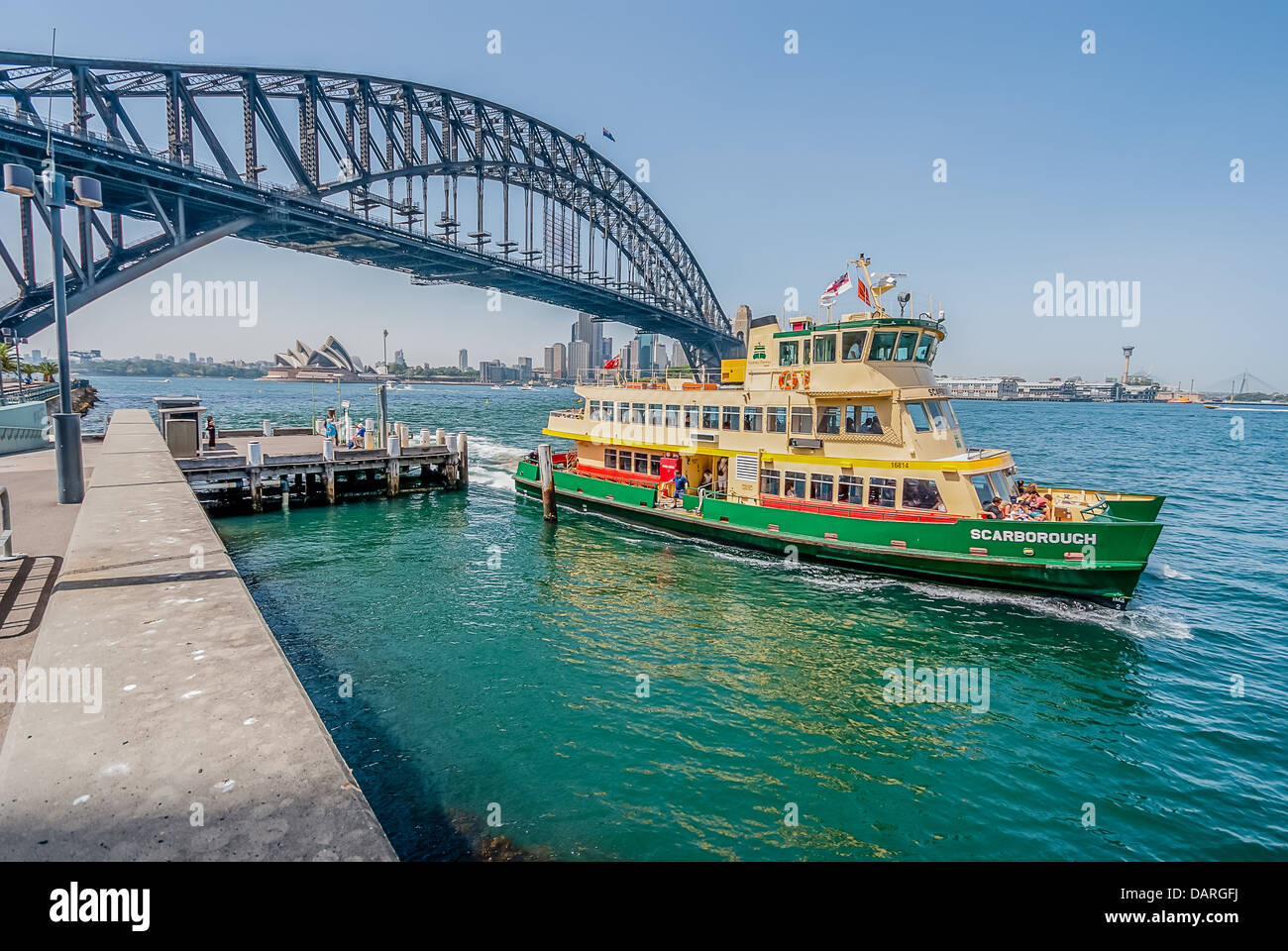 A ferry leaves Milsons Point near the iconic Sydney Harbour Bridge ...