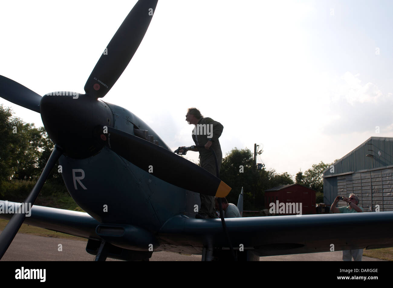 Pilot Peter Teichman refuelling Spitfire Mk XI aircraft at Wellesbourne ...