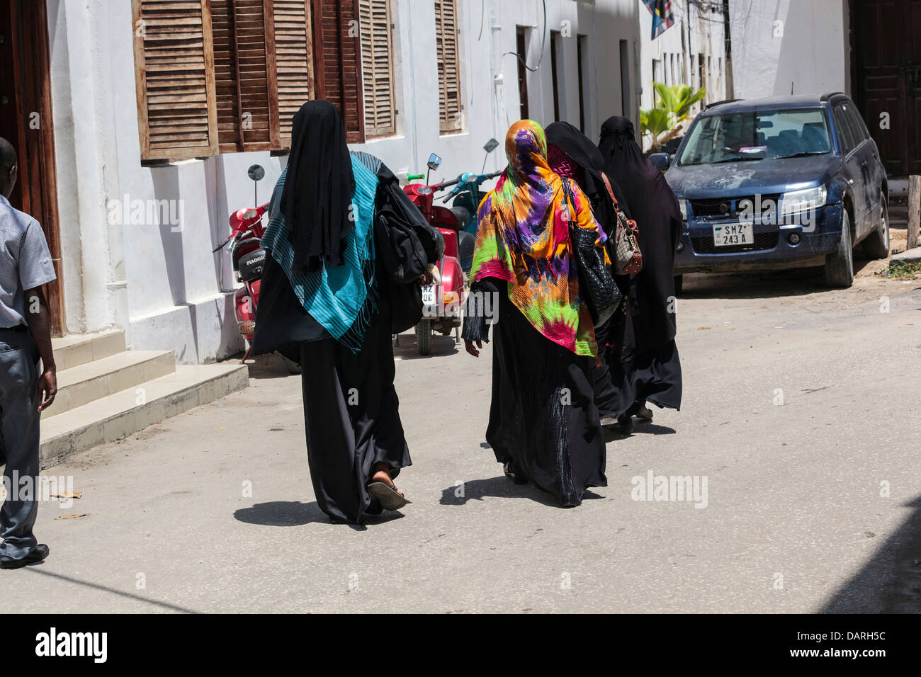 Africa, Tanzania, Zanzibar, Stone Town. Covered Muslim women walking ...