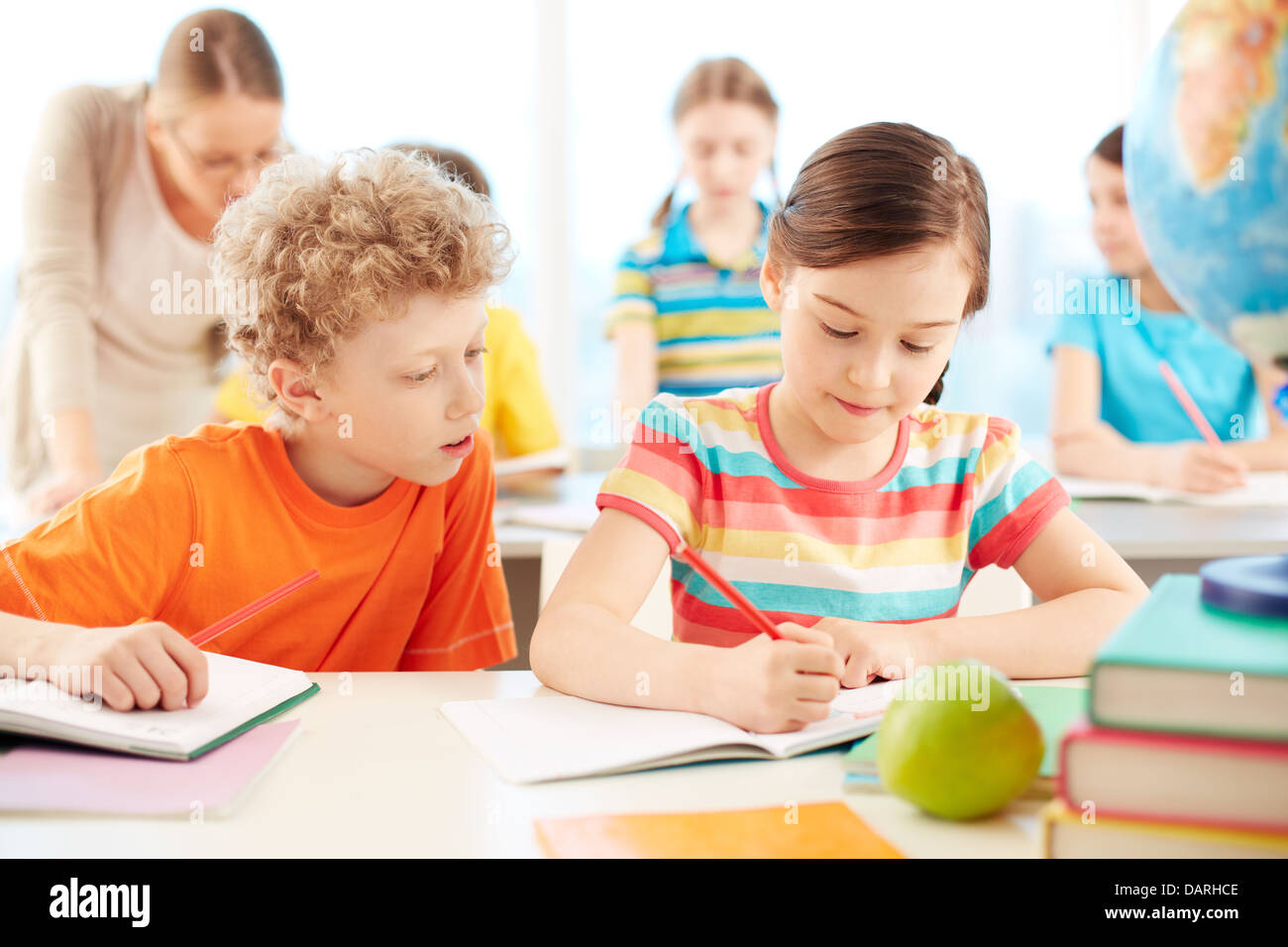Portrait of two diligent pupils drawing at lesson Stock Photo - Alamy