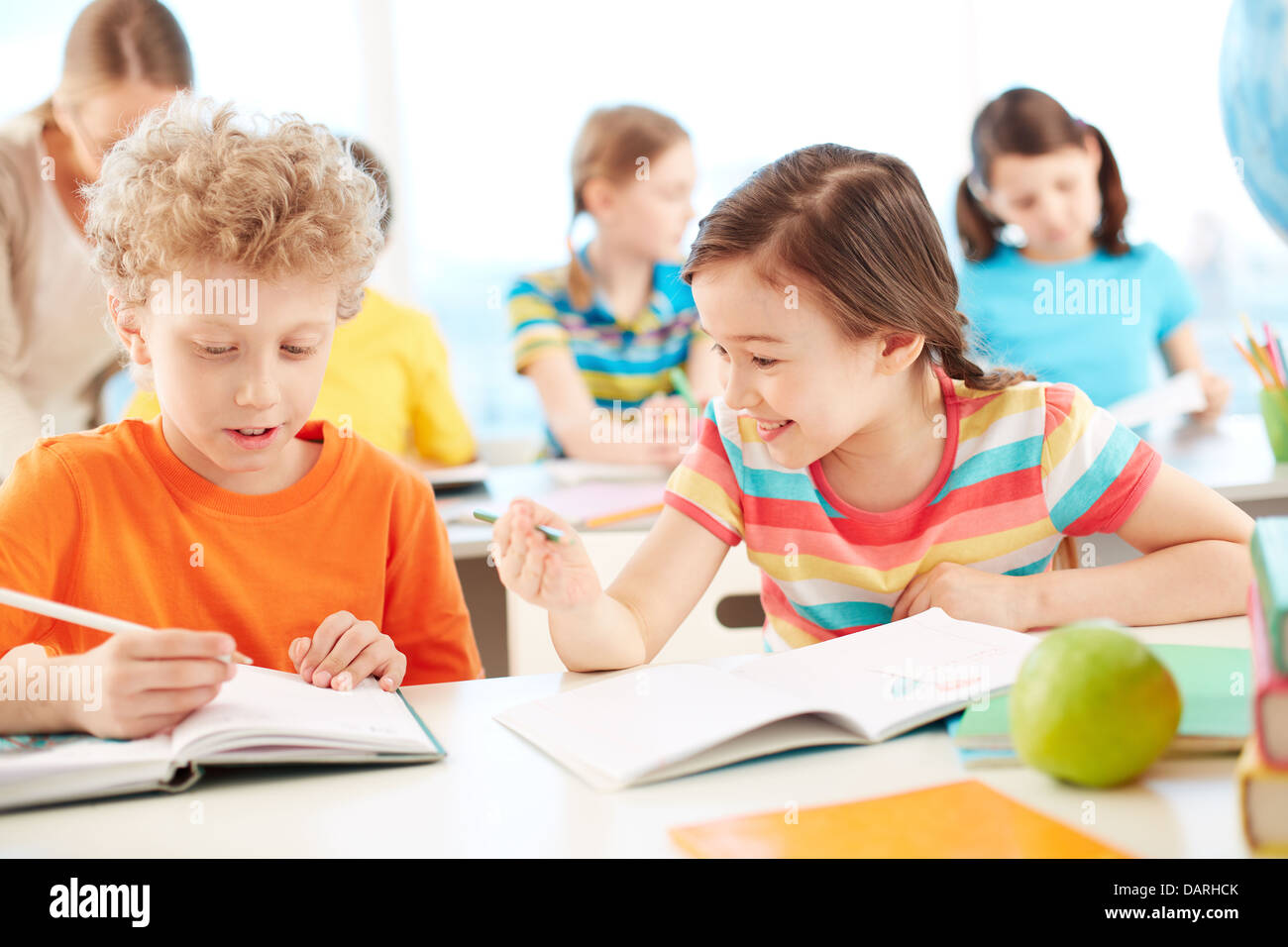 Portrait of two diligent pupils interacting at drawing lesson Stock ...