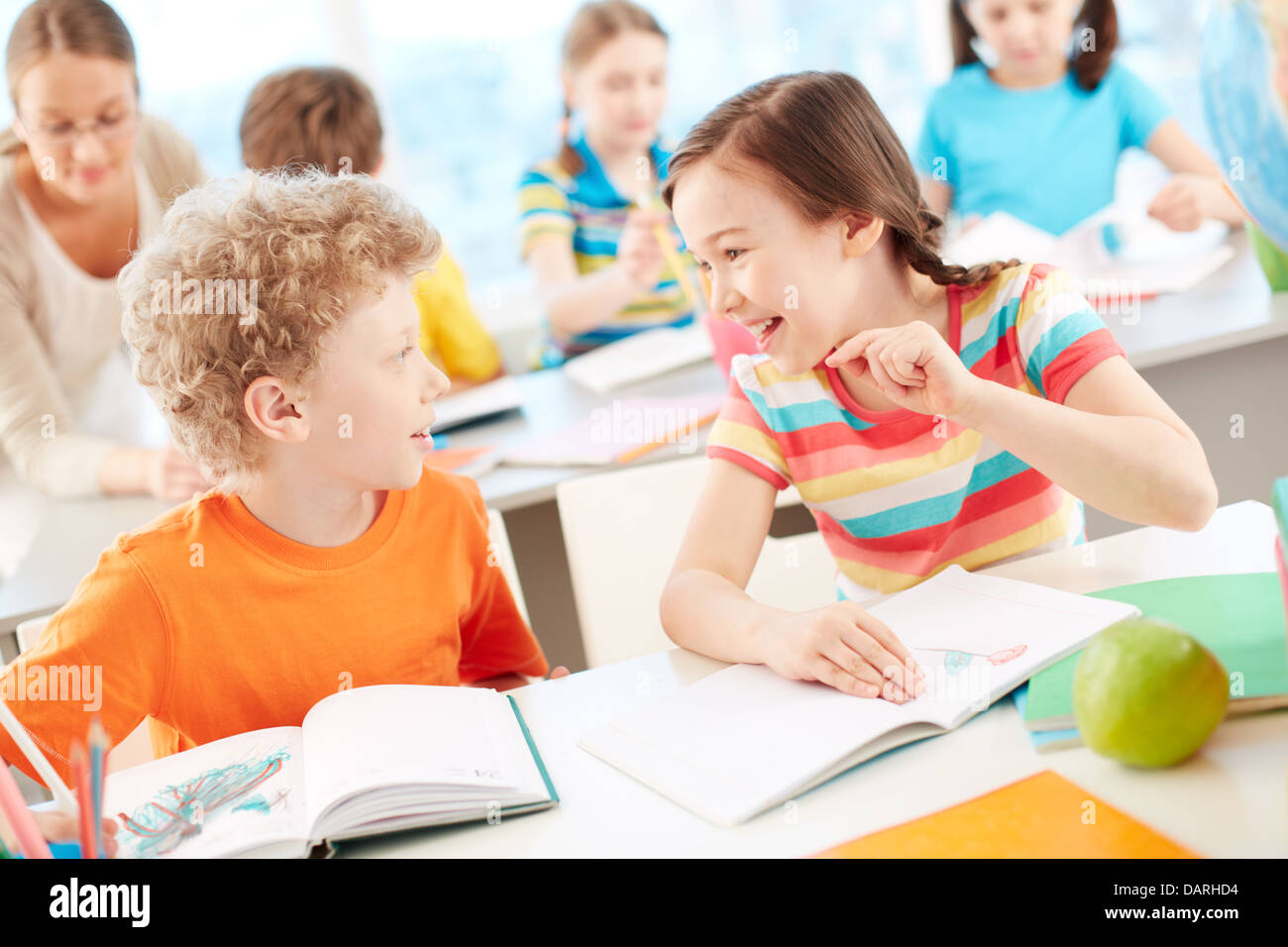Portrait of two happy pupils interacting at drawing lesson Stock Photo ...
