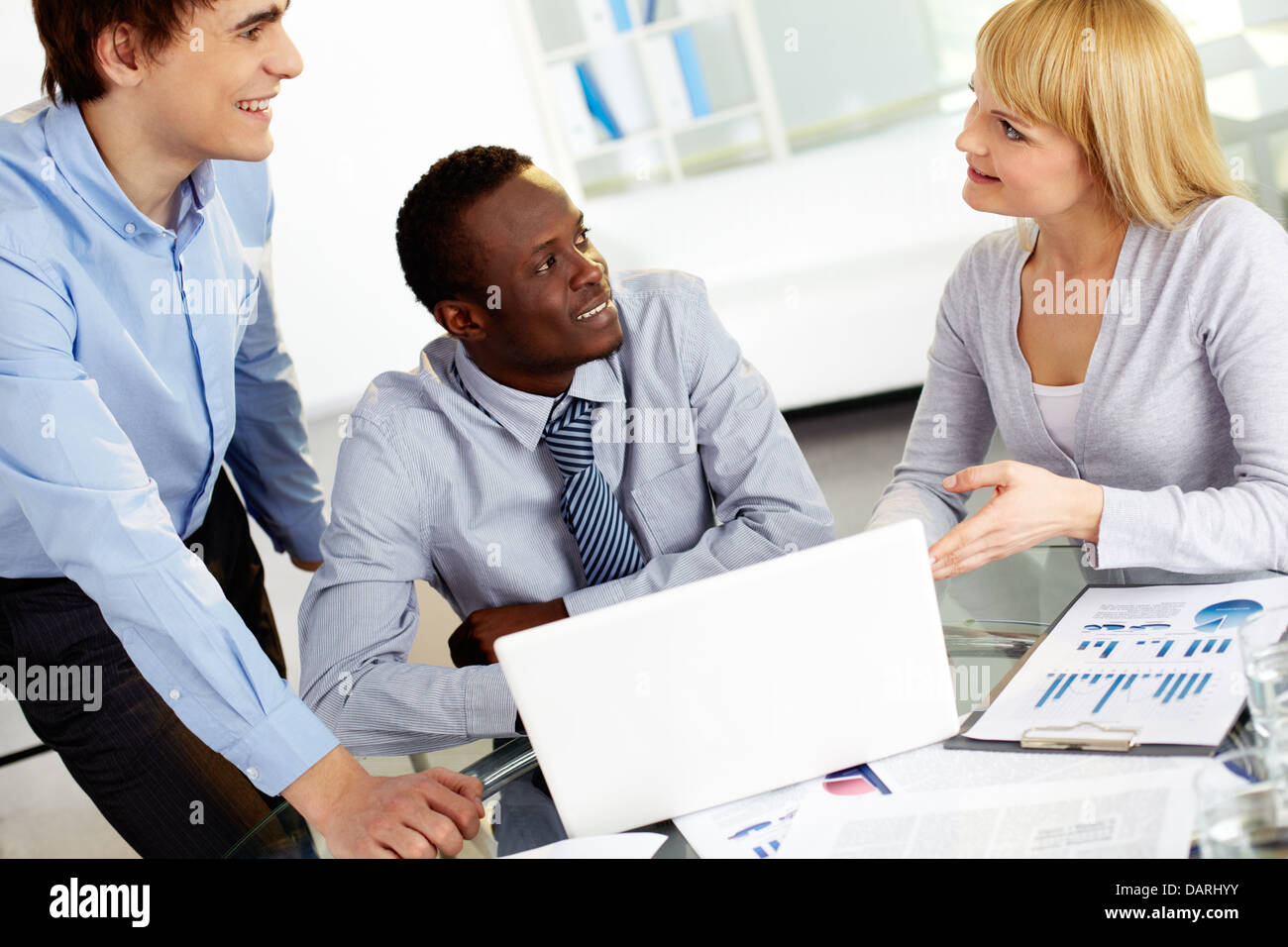 Group of confident business partners planning work and sharing ideas ...