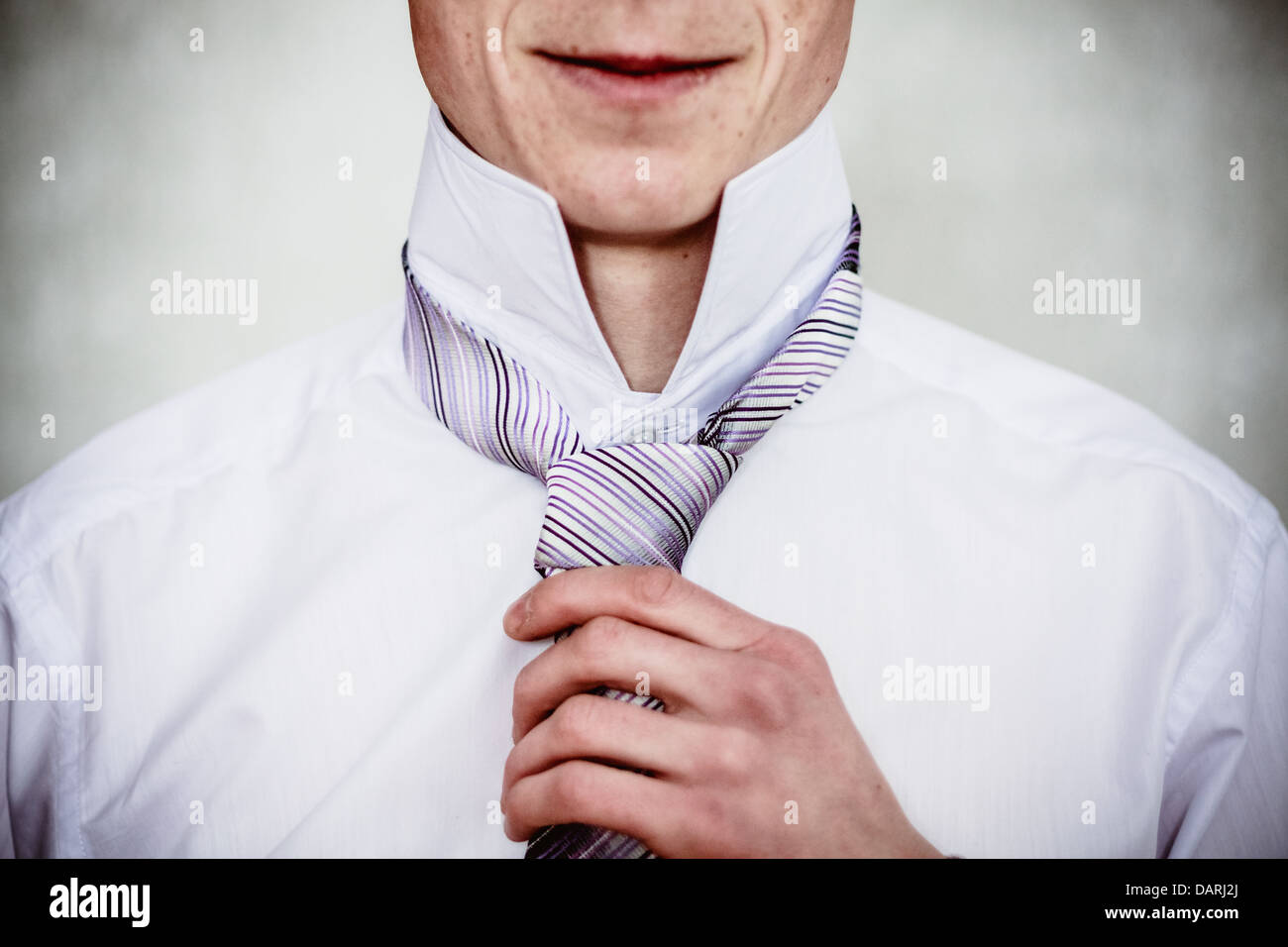 Man fixing his tie Stock Photo - Alamy