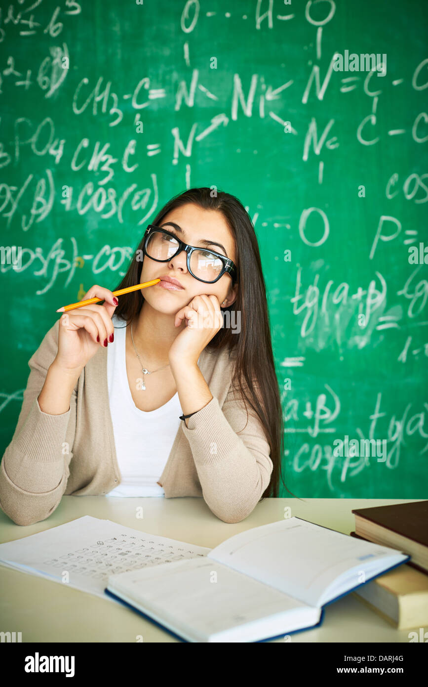 Portrait of pensive student carrying out test at lesson Stock Photo - Alamy