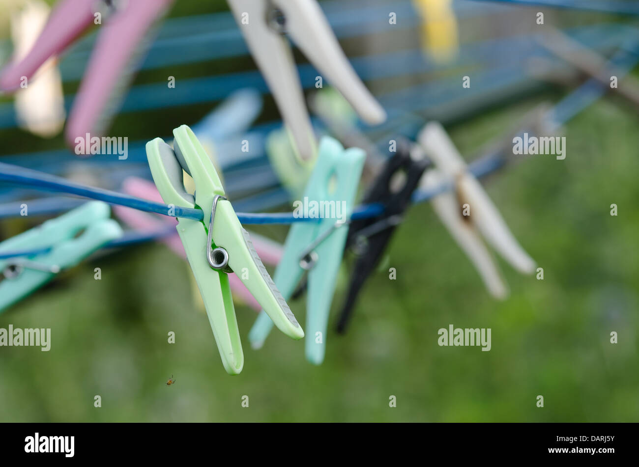 Row of old new wooden plastic clothes pegs on a washing line with out ...