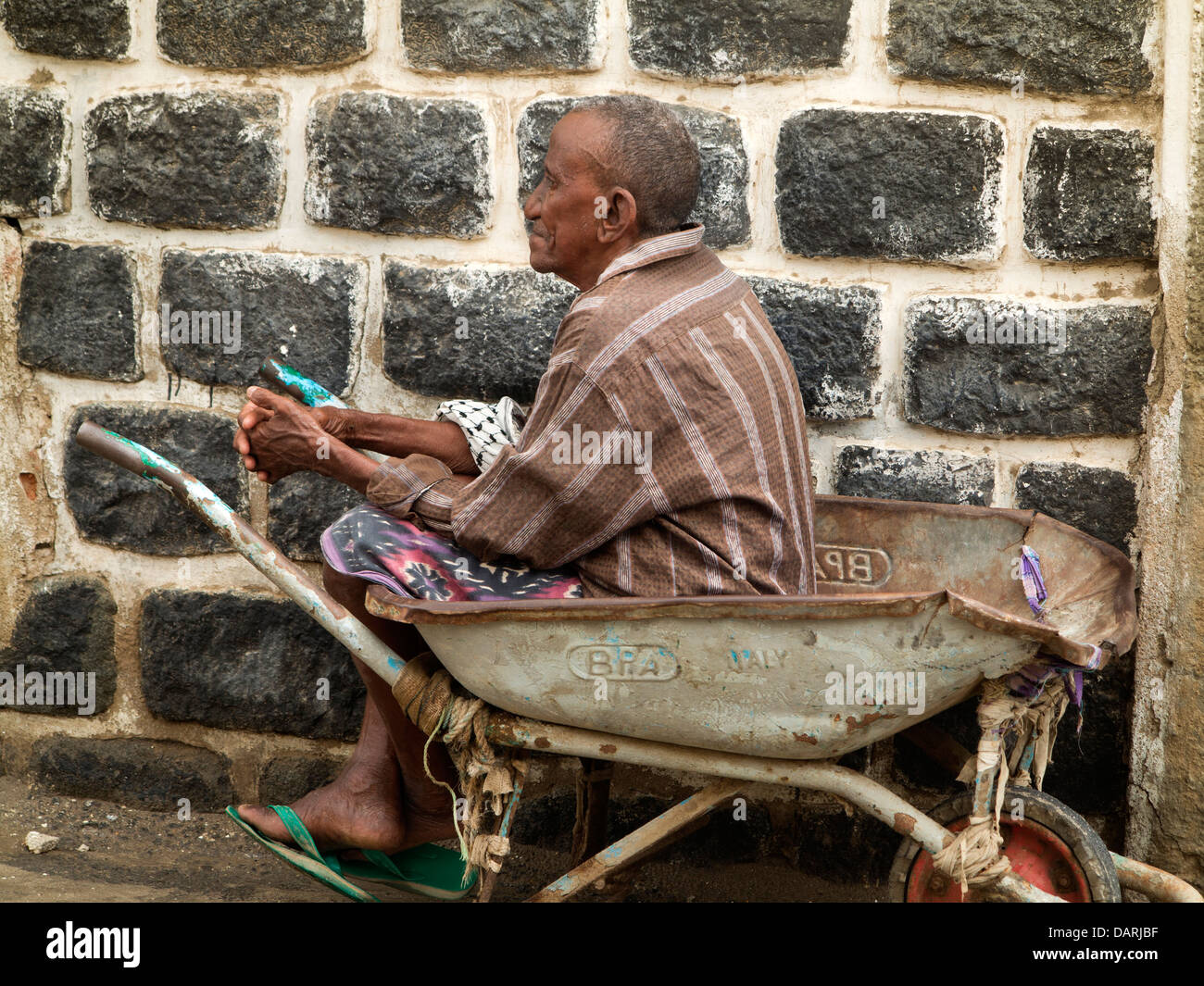 Africa, Eritrea, Massawa, Old Town, Eritrean man sat in old wheelbarrow ...