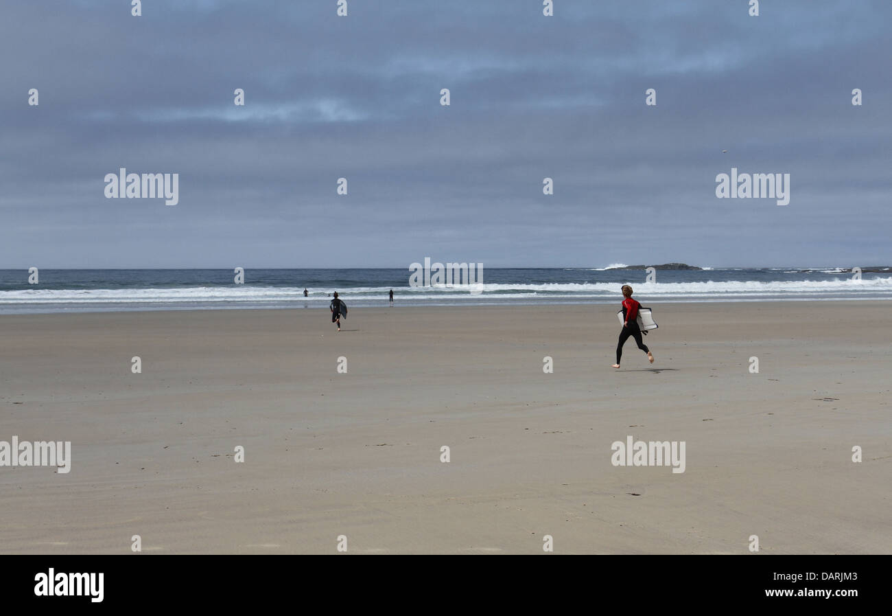 Boy with bodyboard running towards sea Machir bay Isle of Islay ...