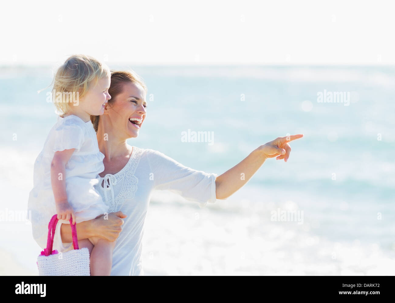 Happy mother with baby pointing on copy space Stock Photo - Alamy