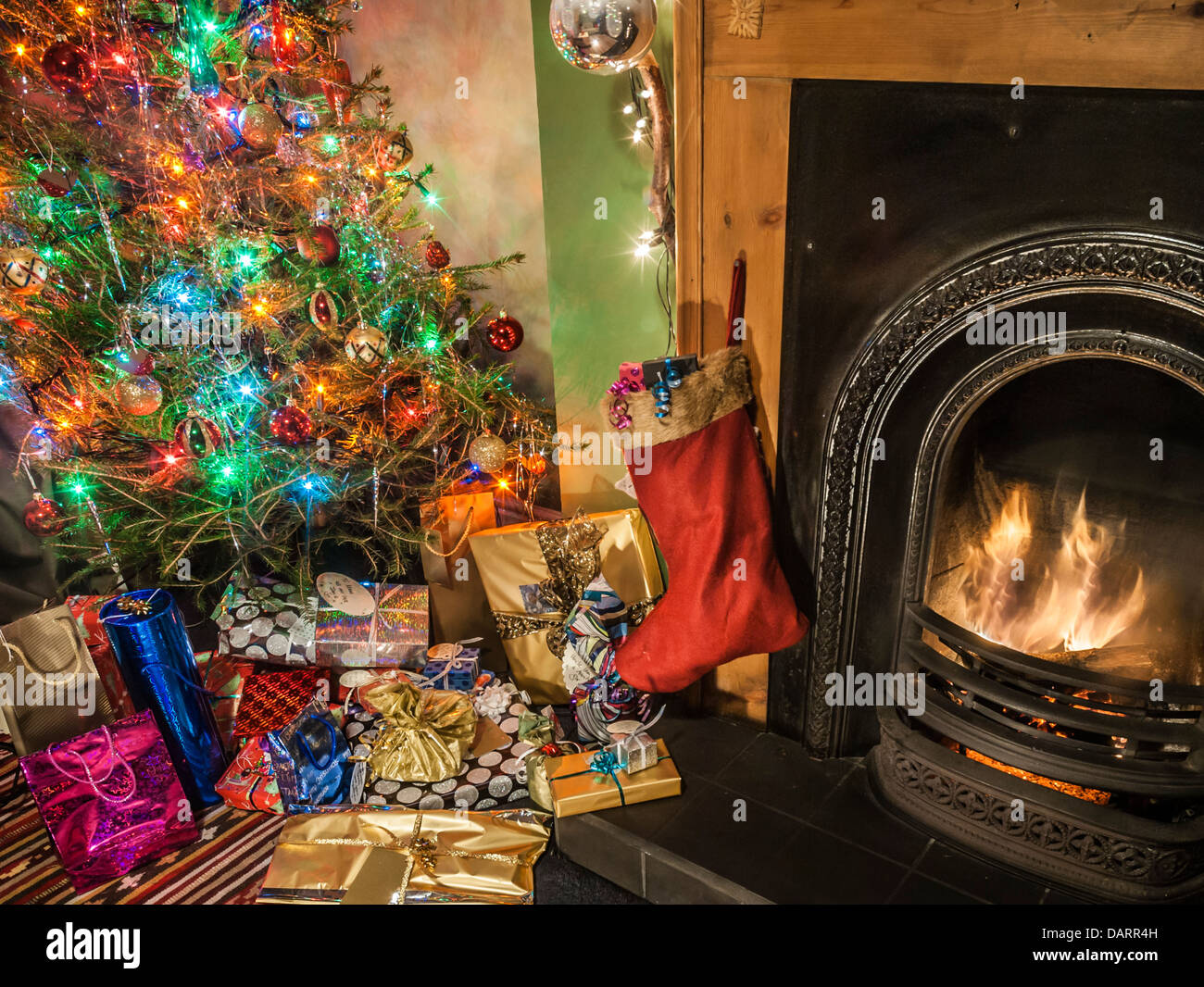 A cosy fireside with Christmas tree, decorations, stocking and presents ...