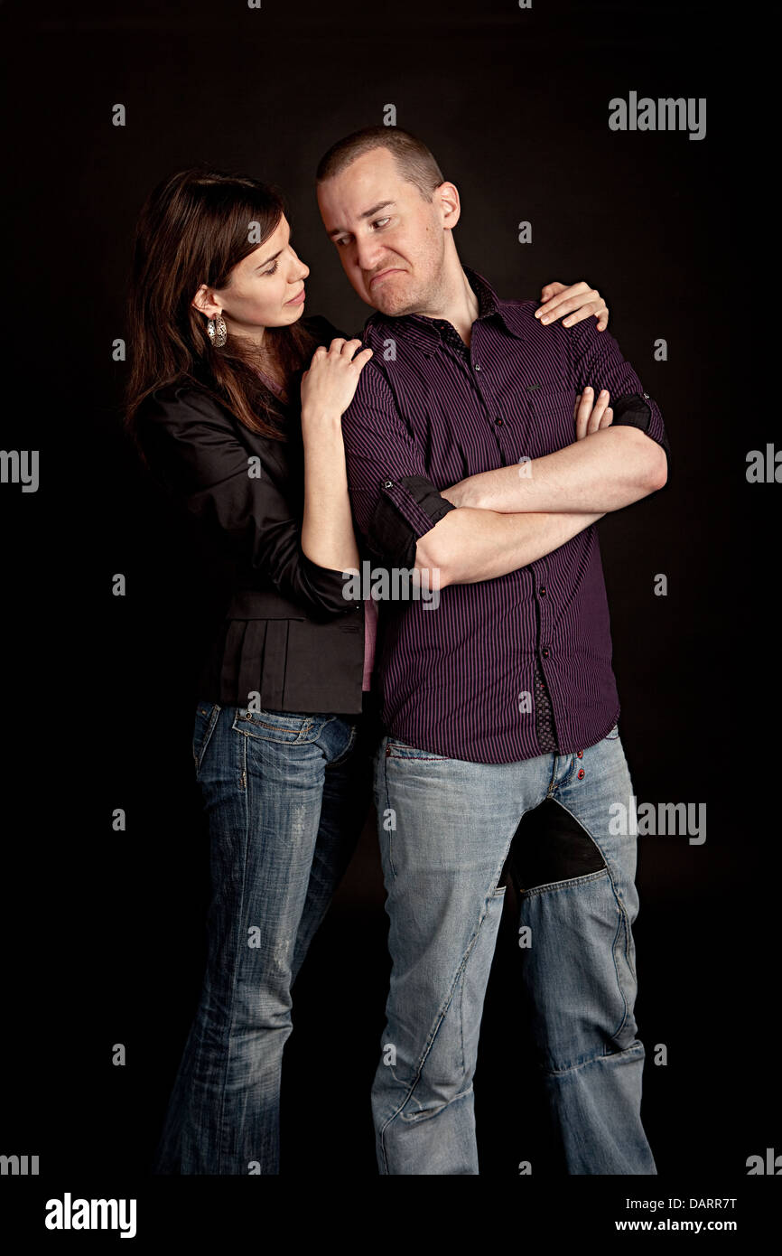 Women embracing sad boyfriend Stock Photo - Alamy