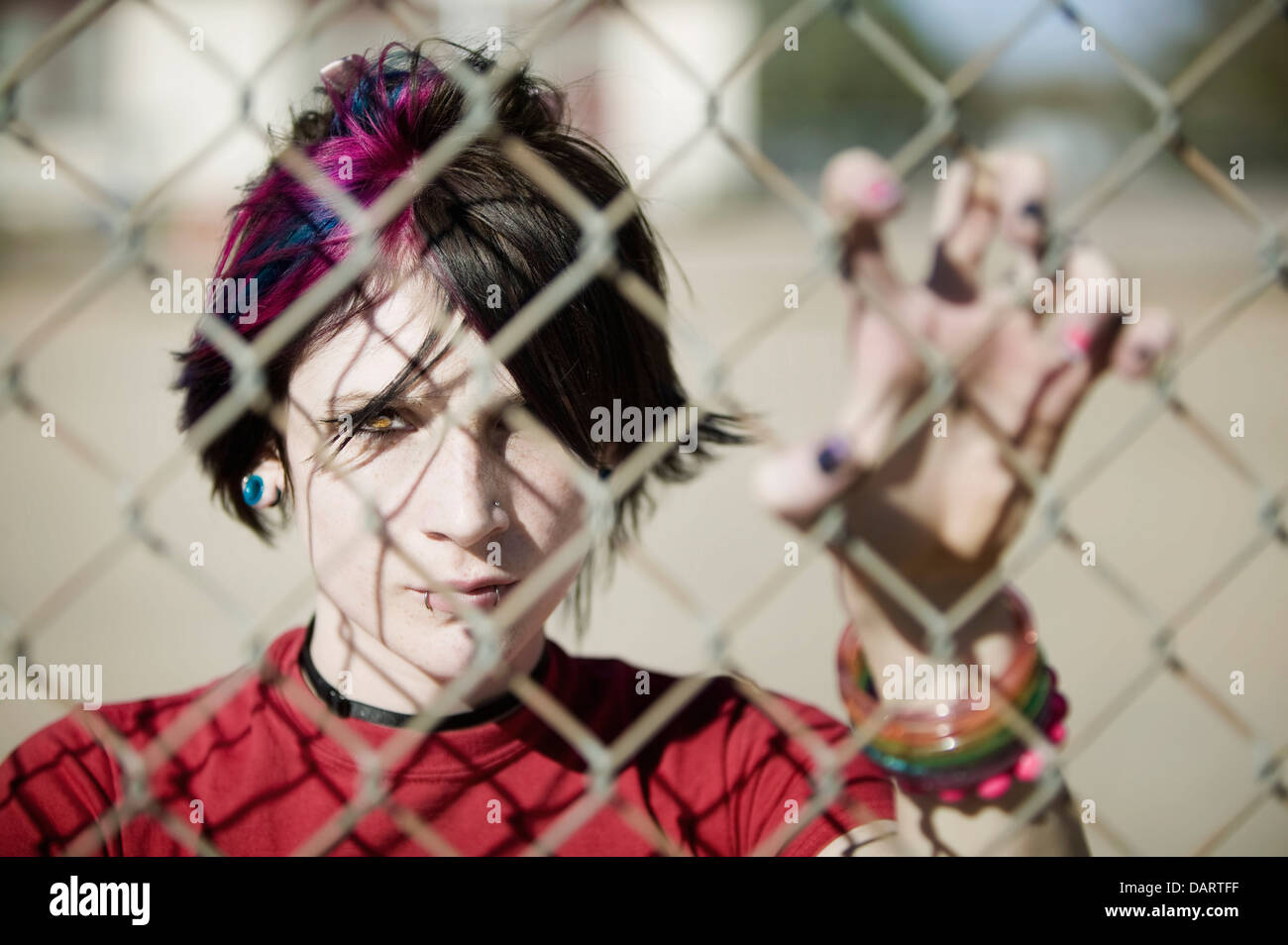 Young woman behind chain link fence hi-res stock photography and images ...