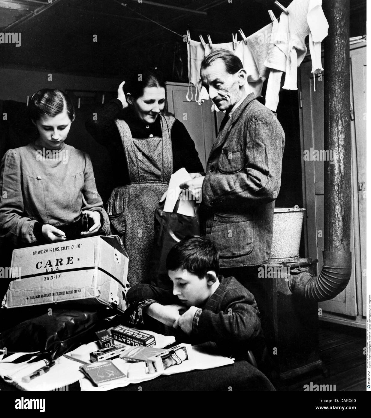 postwar period, CARE programme, German family unpacking a CARE Package ...
