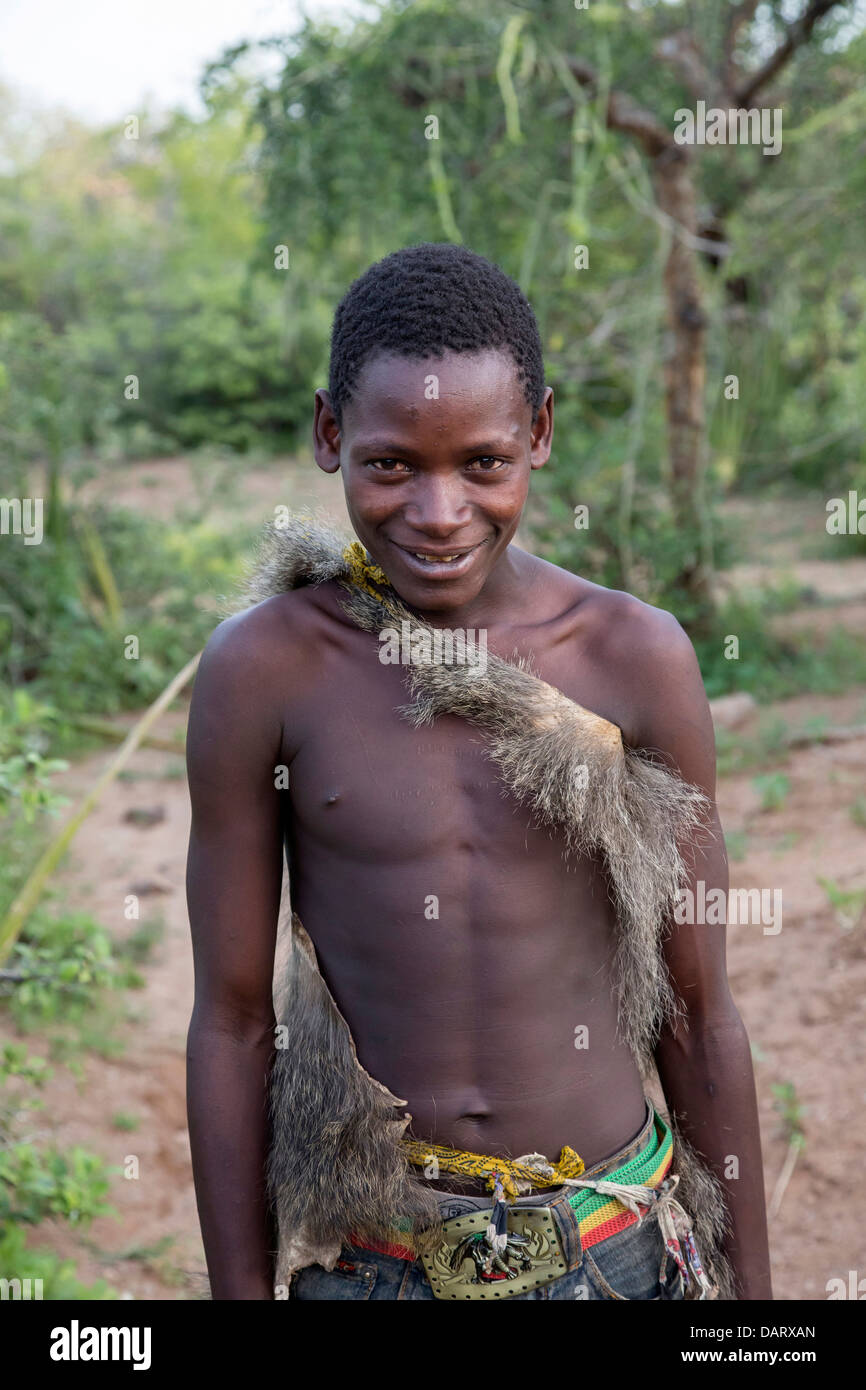 Africa, Tanzania. A young Hadzabe hunter hunting with a bow and ...
