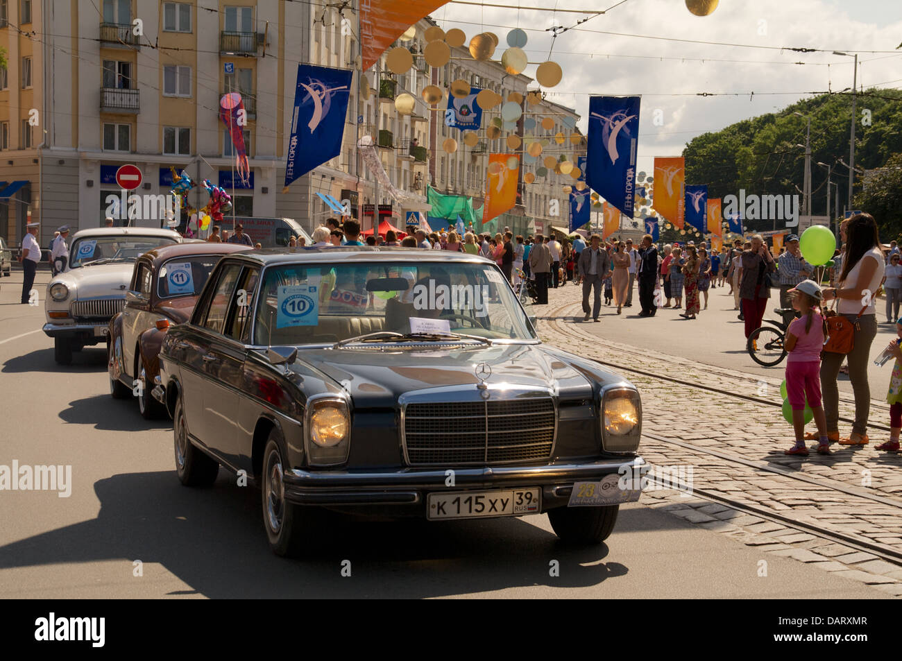 people and retro cars moves at street parade Stock Photo - Alamy