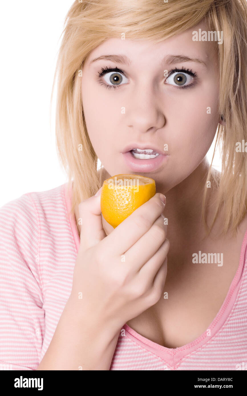 young girl eating lemon Stock Photo - Alamy