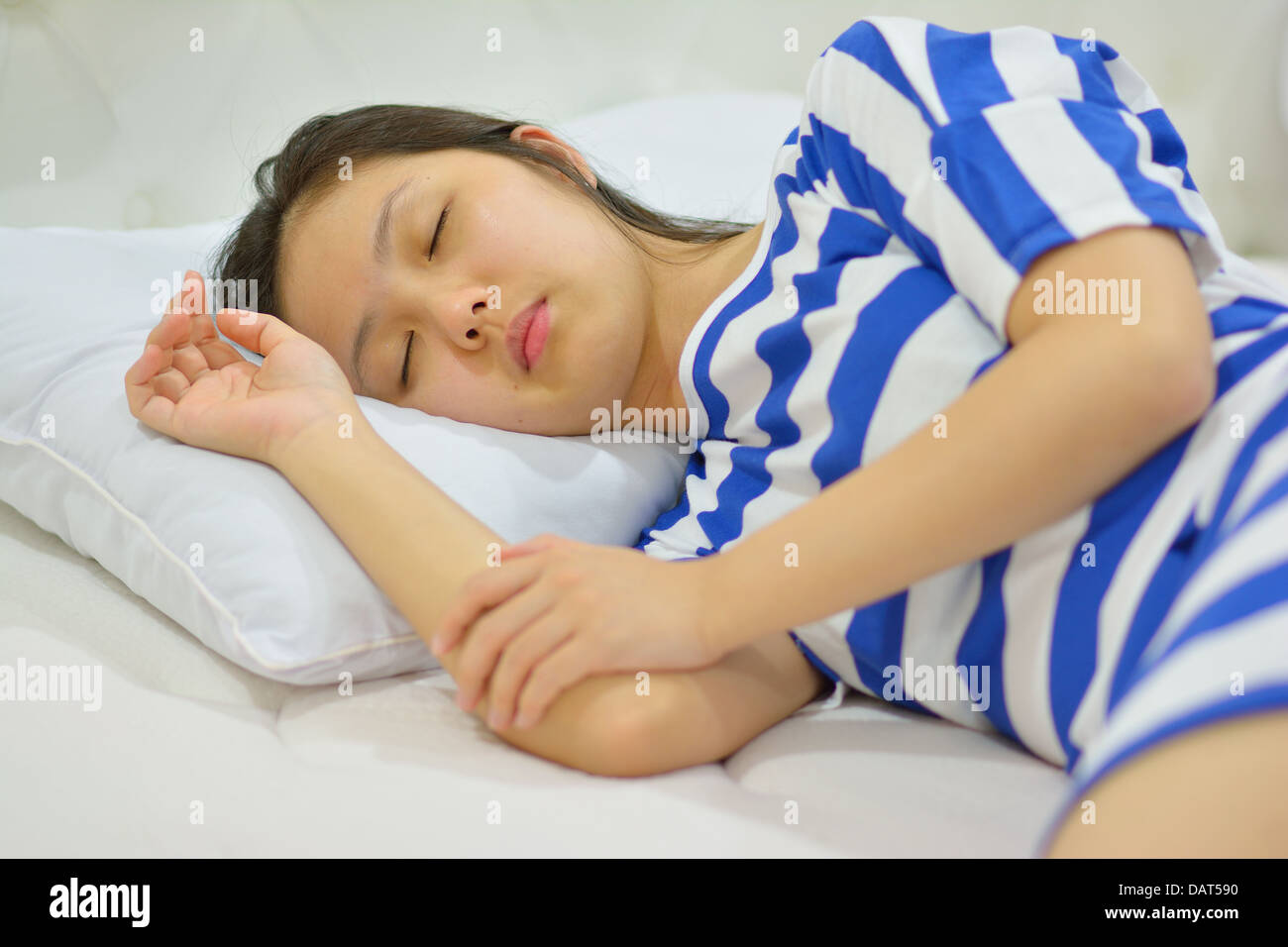 young woman sleeping on bed in bedroom Stock Photo - Alamy