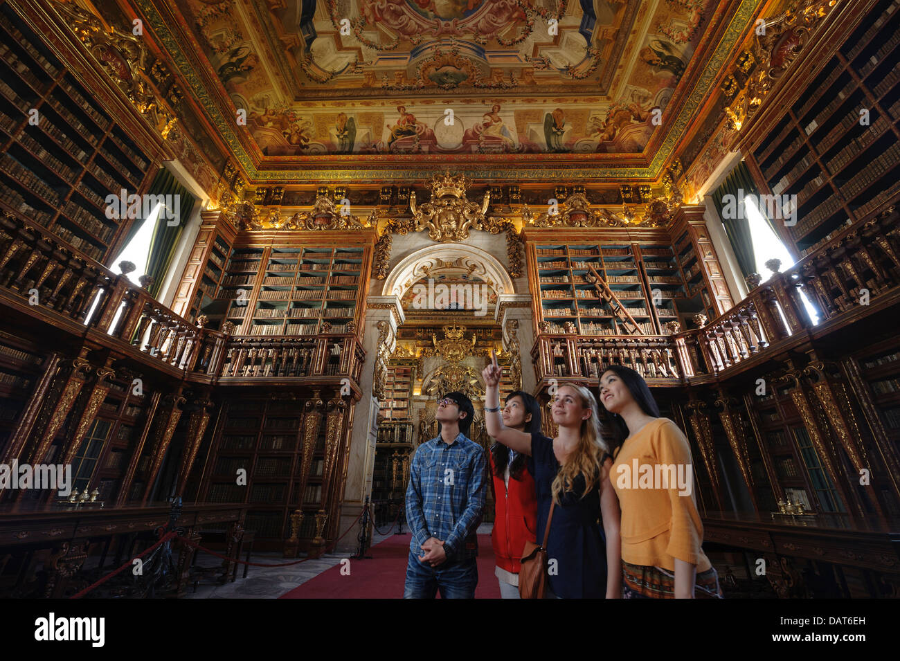 People visiting Coimbra University's 18th century baroque library ...
