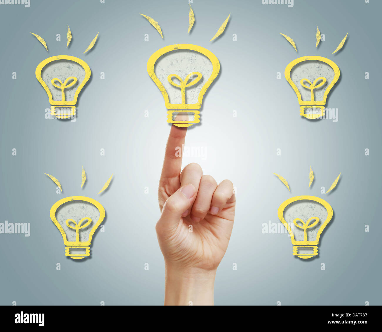 Female hand pushing light bulb icons on gray background Stock Photo - Alamy