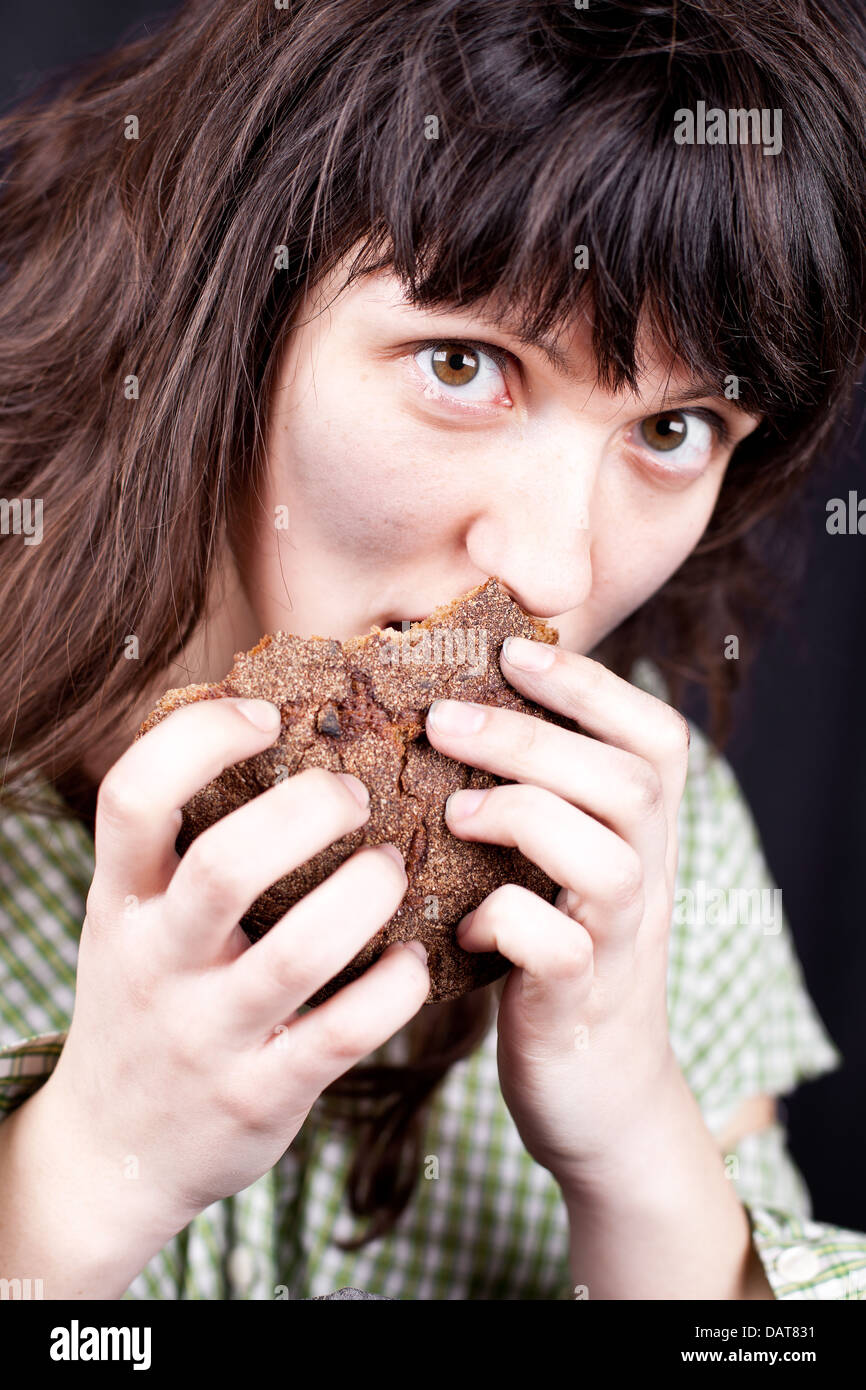 beggar woman eating bread Stock Photo - Alamy